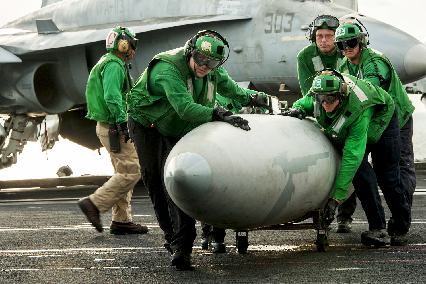 U.S. sailors assigned to Strike Fighter Squadron 94 maneuver a drop ...