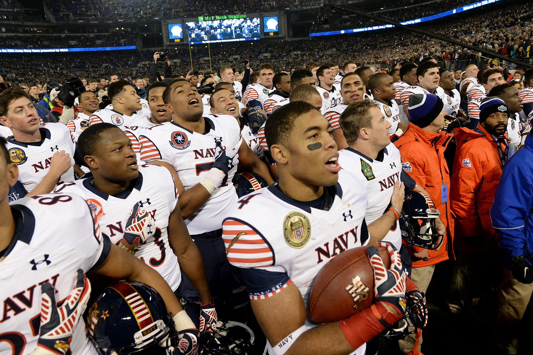 Navy wide receiver Jamir Tillman holds the game ball as the Navy team ...