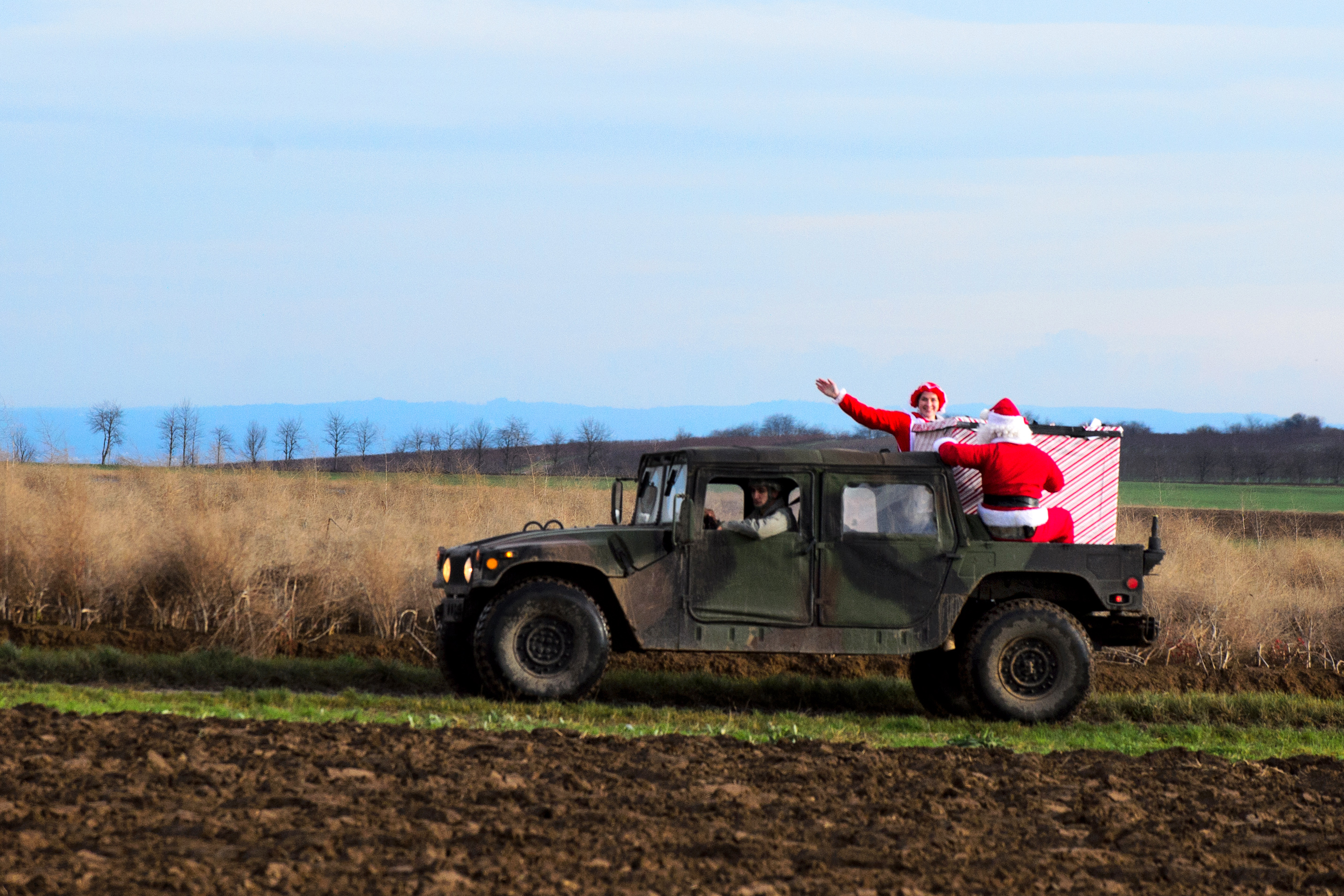 Santa rides in a U.S. Army Humvee after dropping from an Air Force C ...