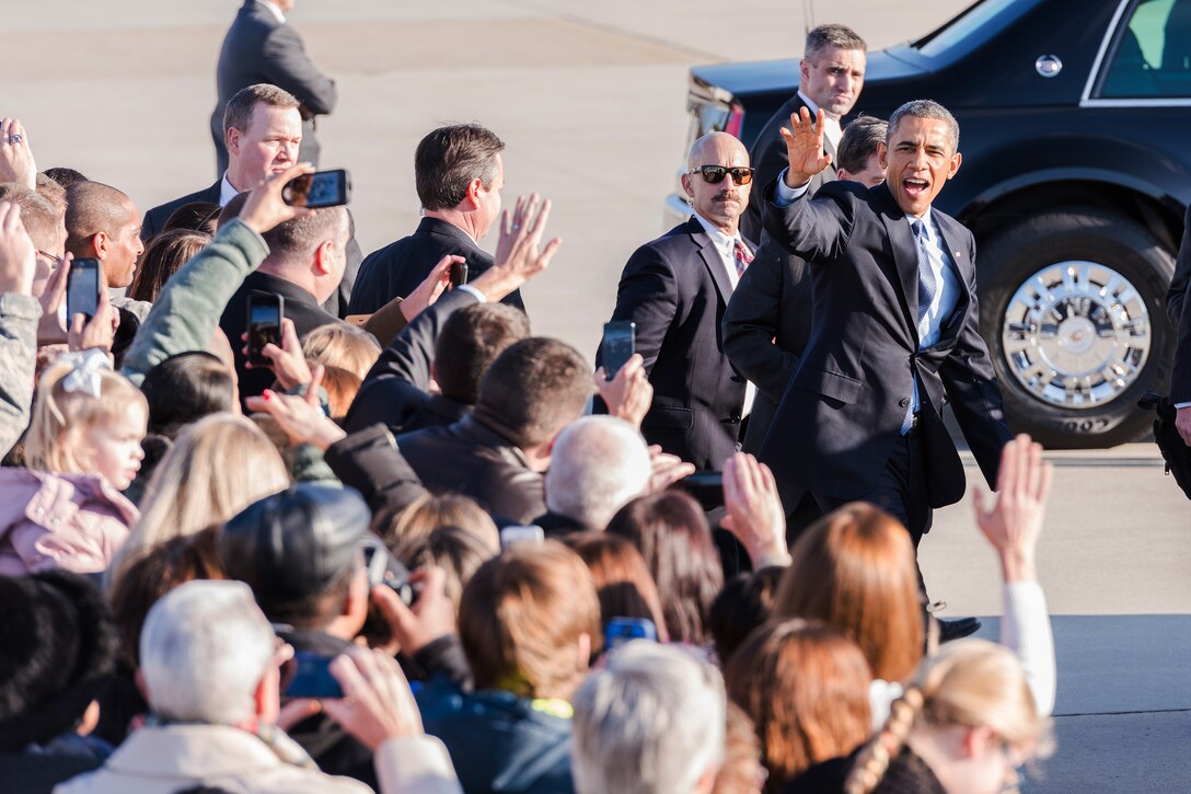 President Barack Obama waves at a crowd at McGuire Field on Joint Base ...