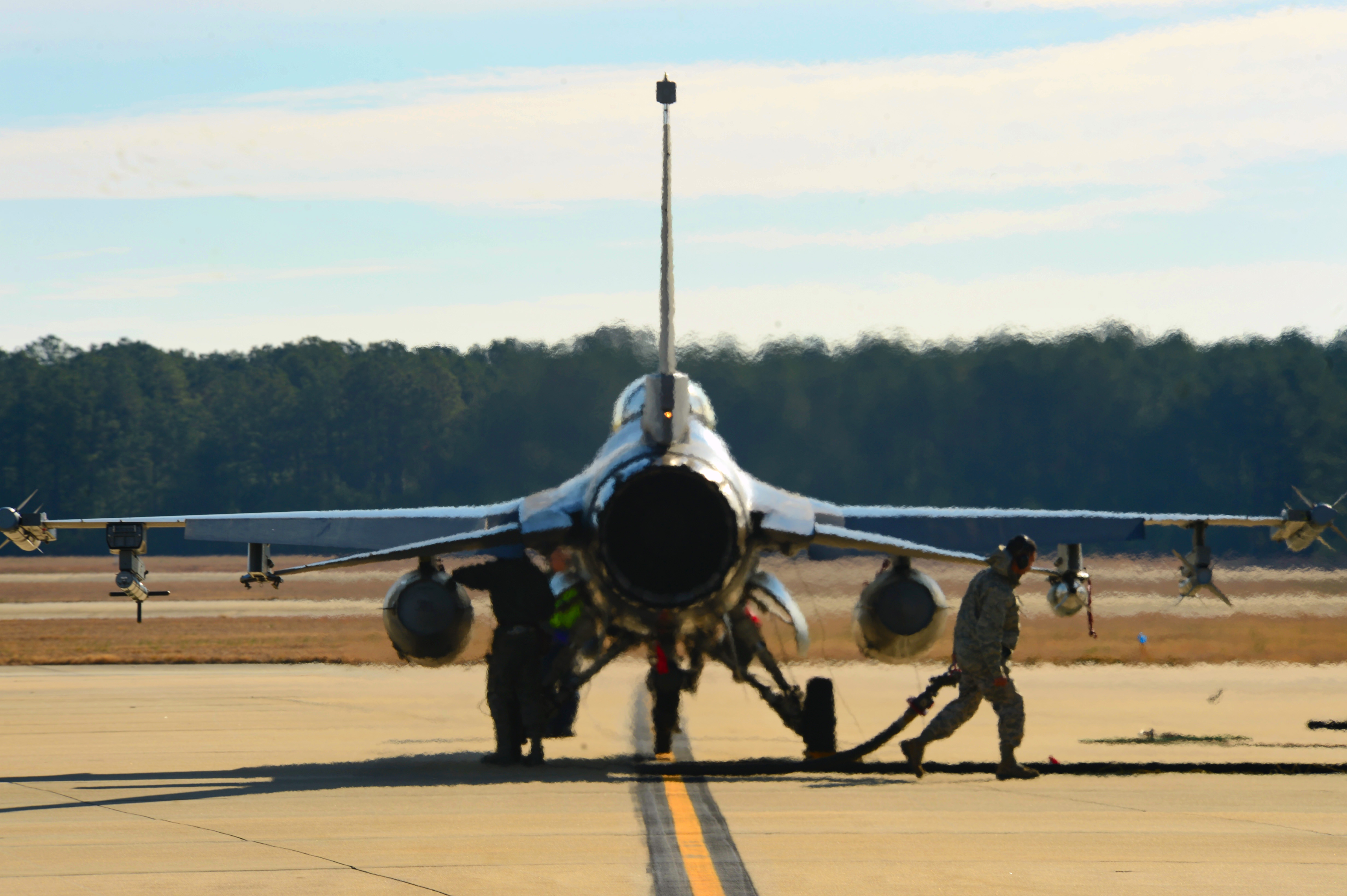 Airmen perform hot pit refueling