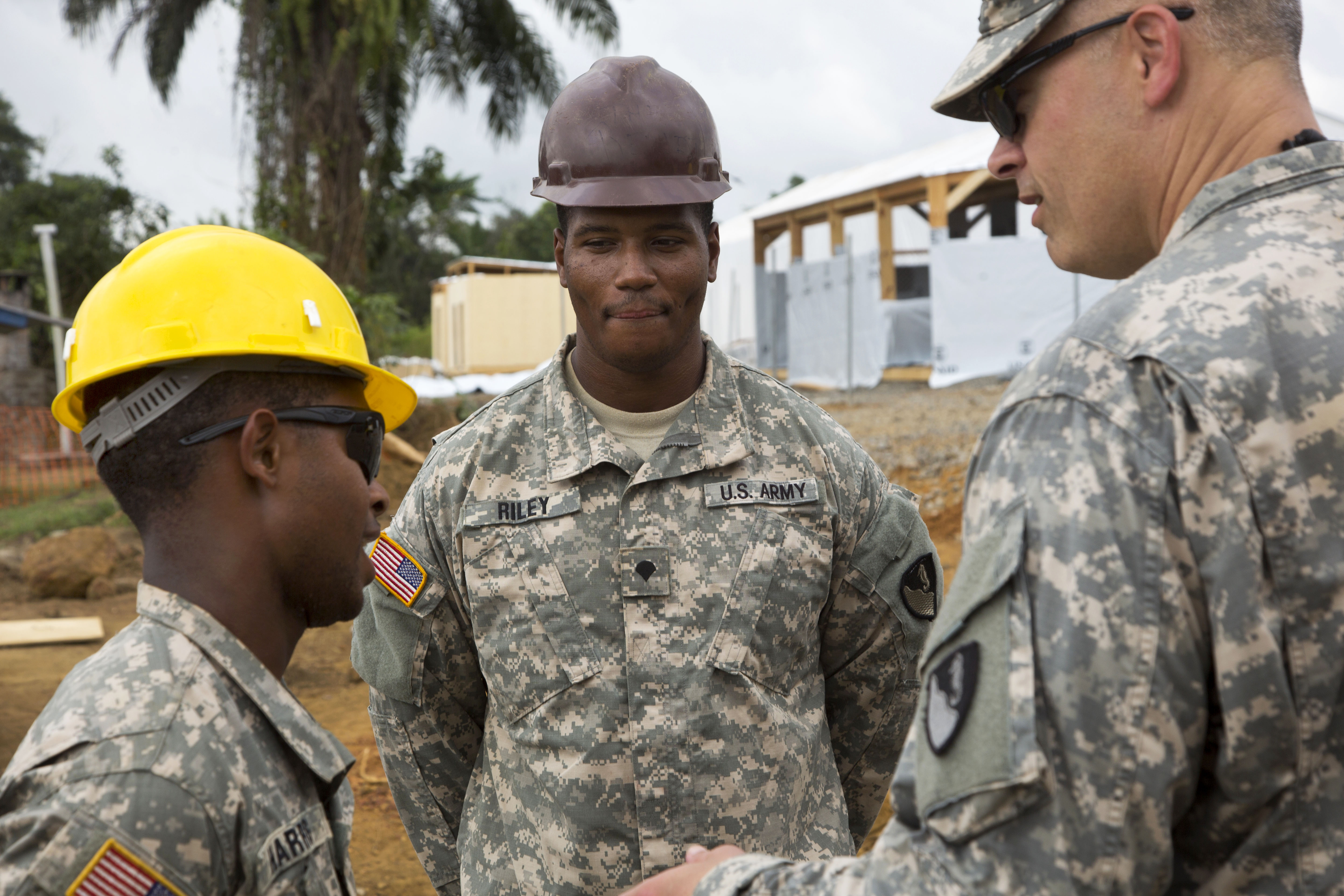 U.S. Army Pfc. Shane Harris, left, and U.S. Army Spc. Ike Riley, center ...