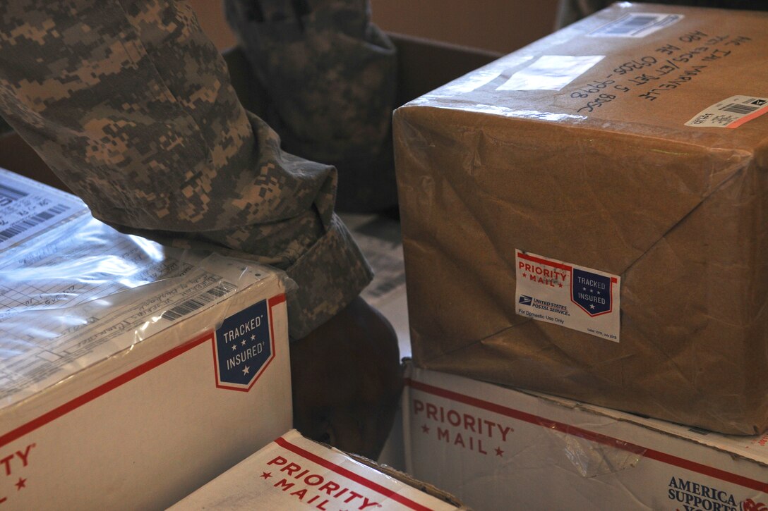 U.S. Army Spc. Mark Bickley sorts mail at the Joint Military Mail ...