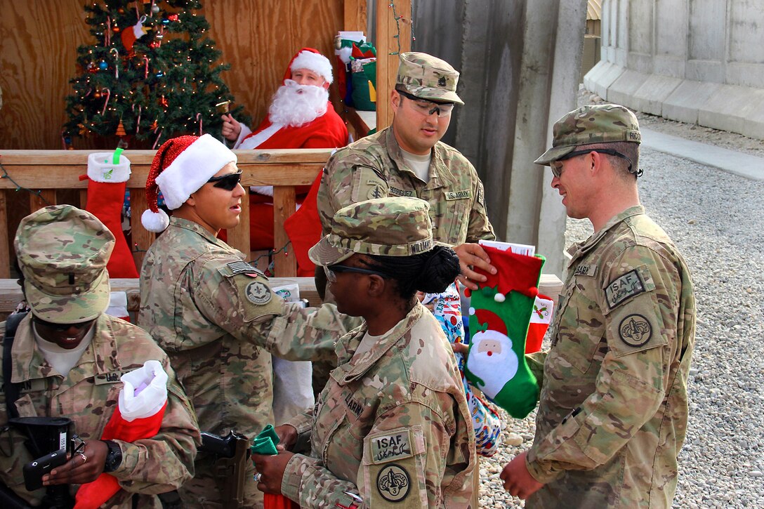 U.S. soldiers line up to receive stockings with presents and treats ...