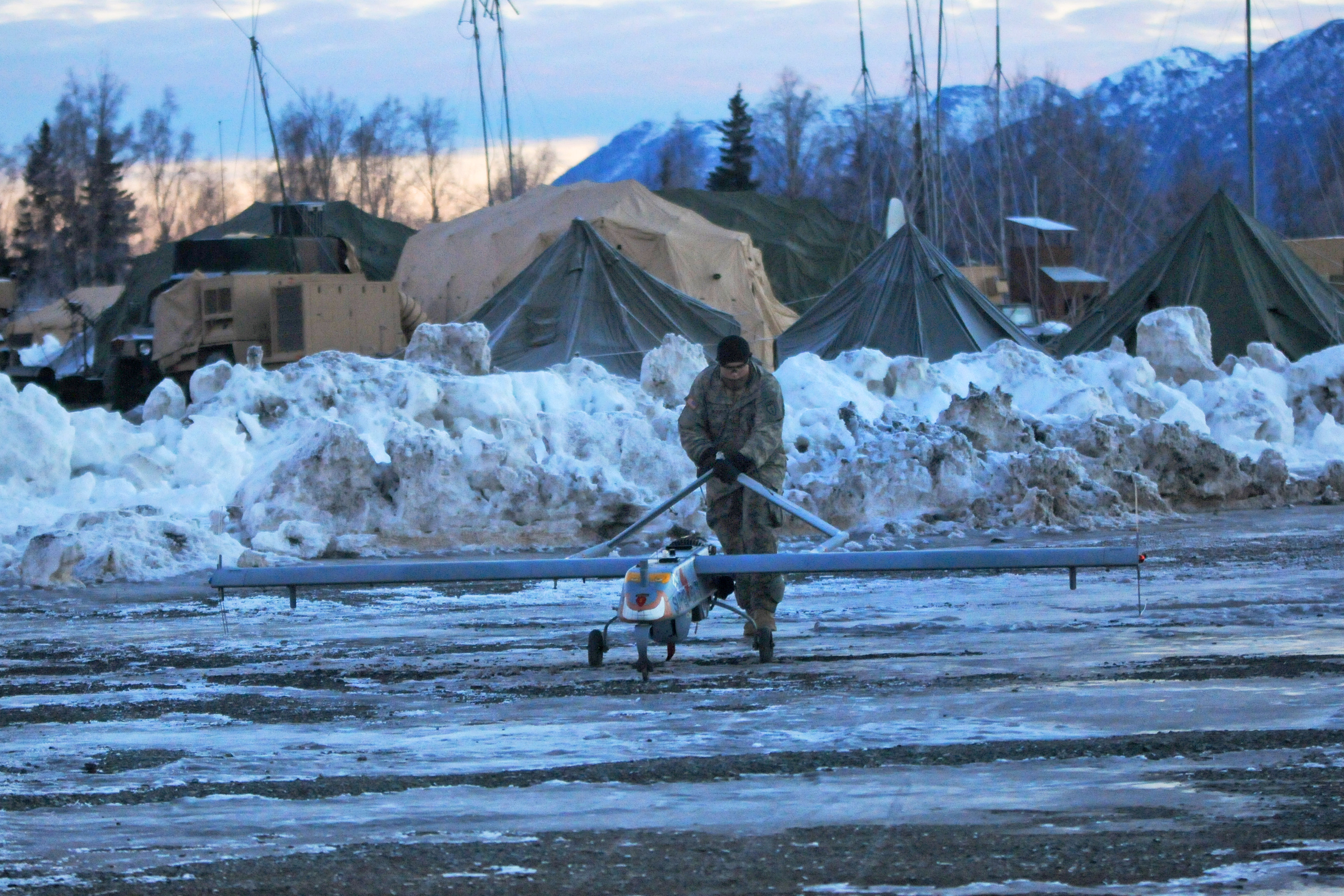 A paratrooper pushes an RQ7 Shadow unmanned aircraft system toward its ...