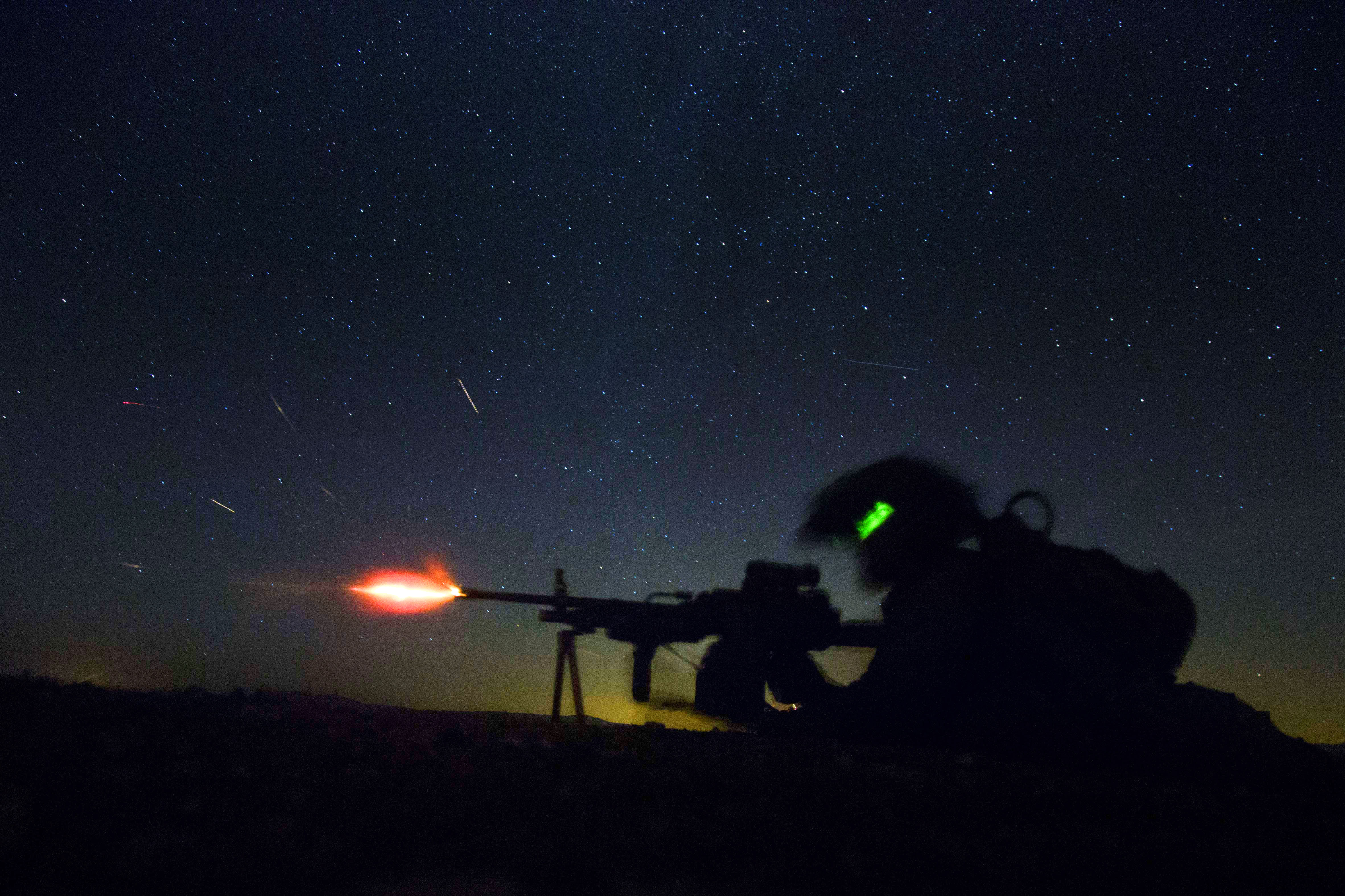 An Army Ranger fires his weapon at a target during a night live-fire ...