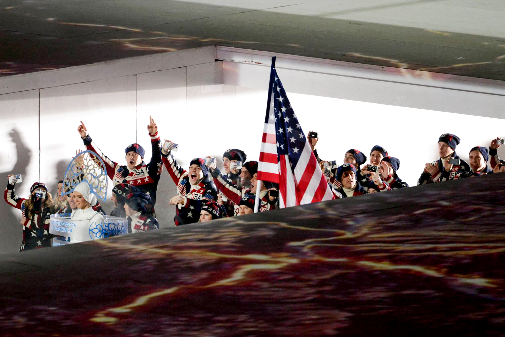 U.S. Army Sgt. Justen Olsen, arms upraised, a 2010 Olympic gold ...