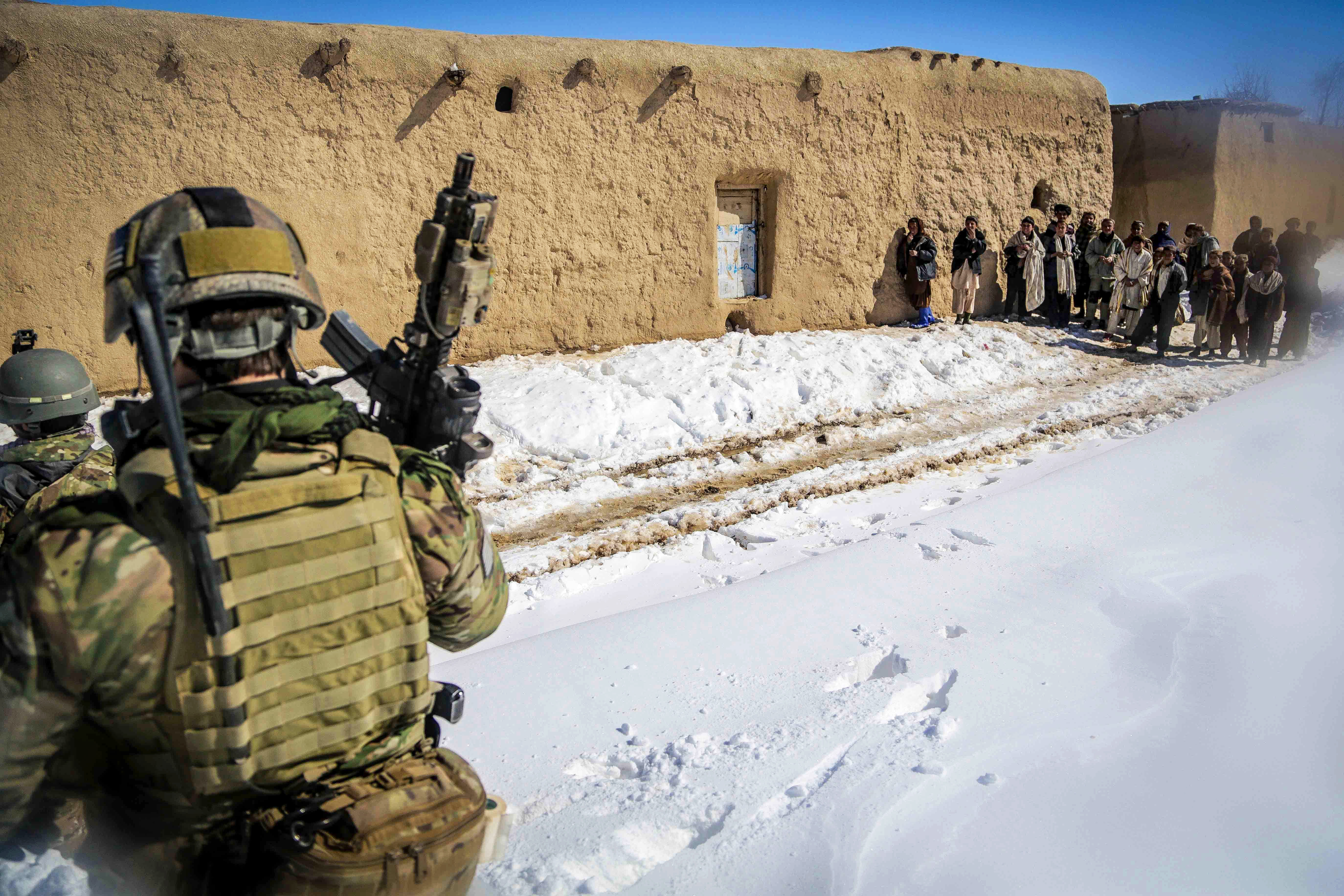 Afghan villagers watch as U.S. special forces soldiers and Afghan ...