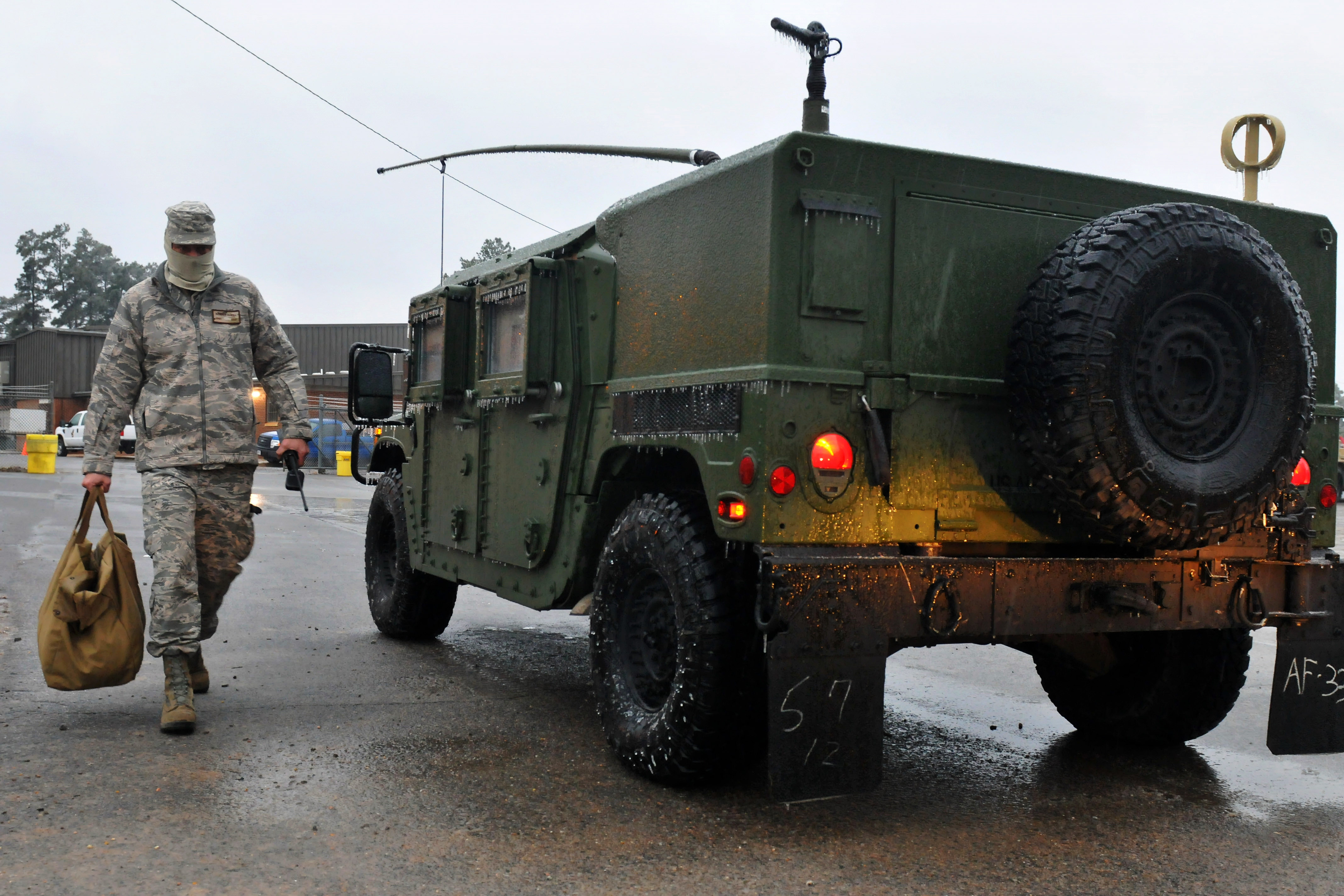 An airman loads a Humvee with critical supplies at the 878th Engineer ...