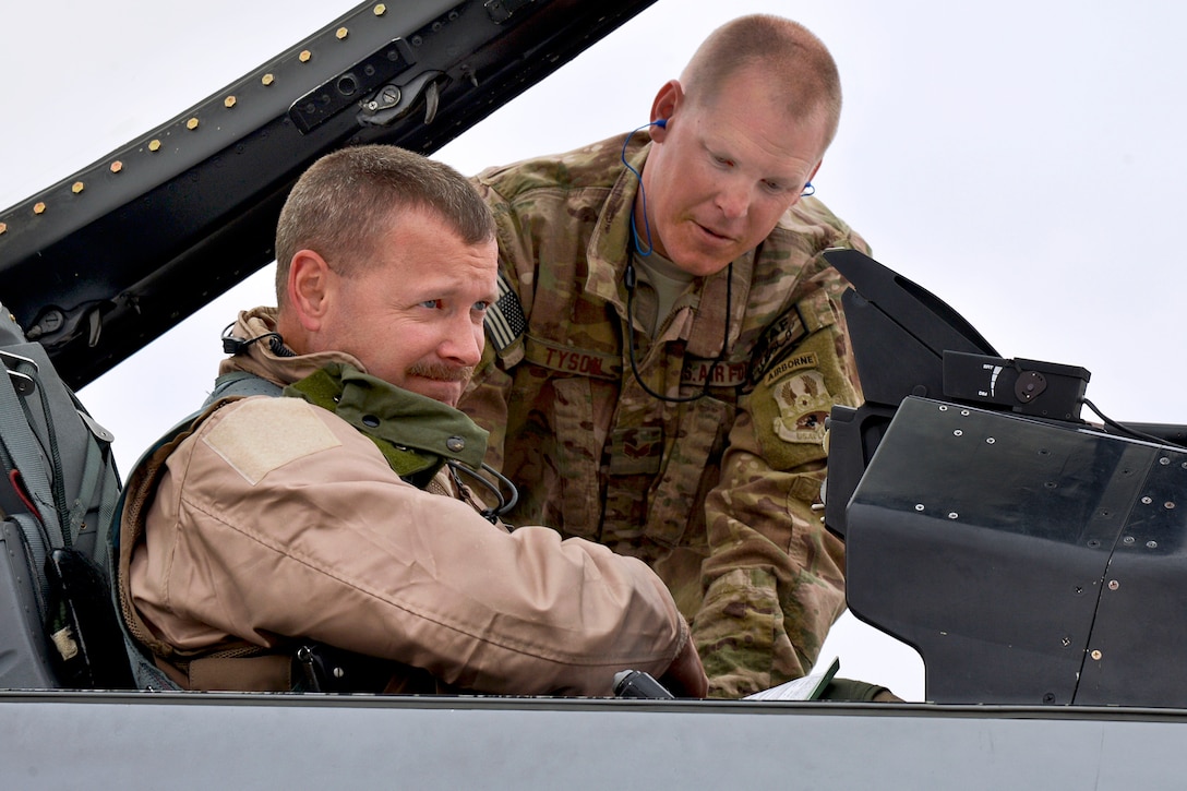 U.S. Air Force Senior Airman Zac Tyson, back, secures U.S. Air Force Lt ...
