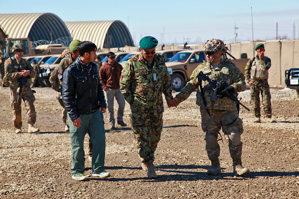 U.S. Army Lt. Col Reynold Arredondo, right, greets Afghan army Lt. Col ...