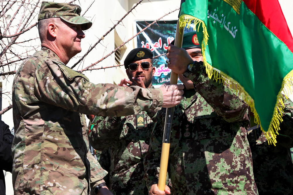 U.S. Army Brig. Gen. David Haight presents a flag as a gift to Afghan ...
