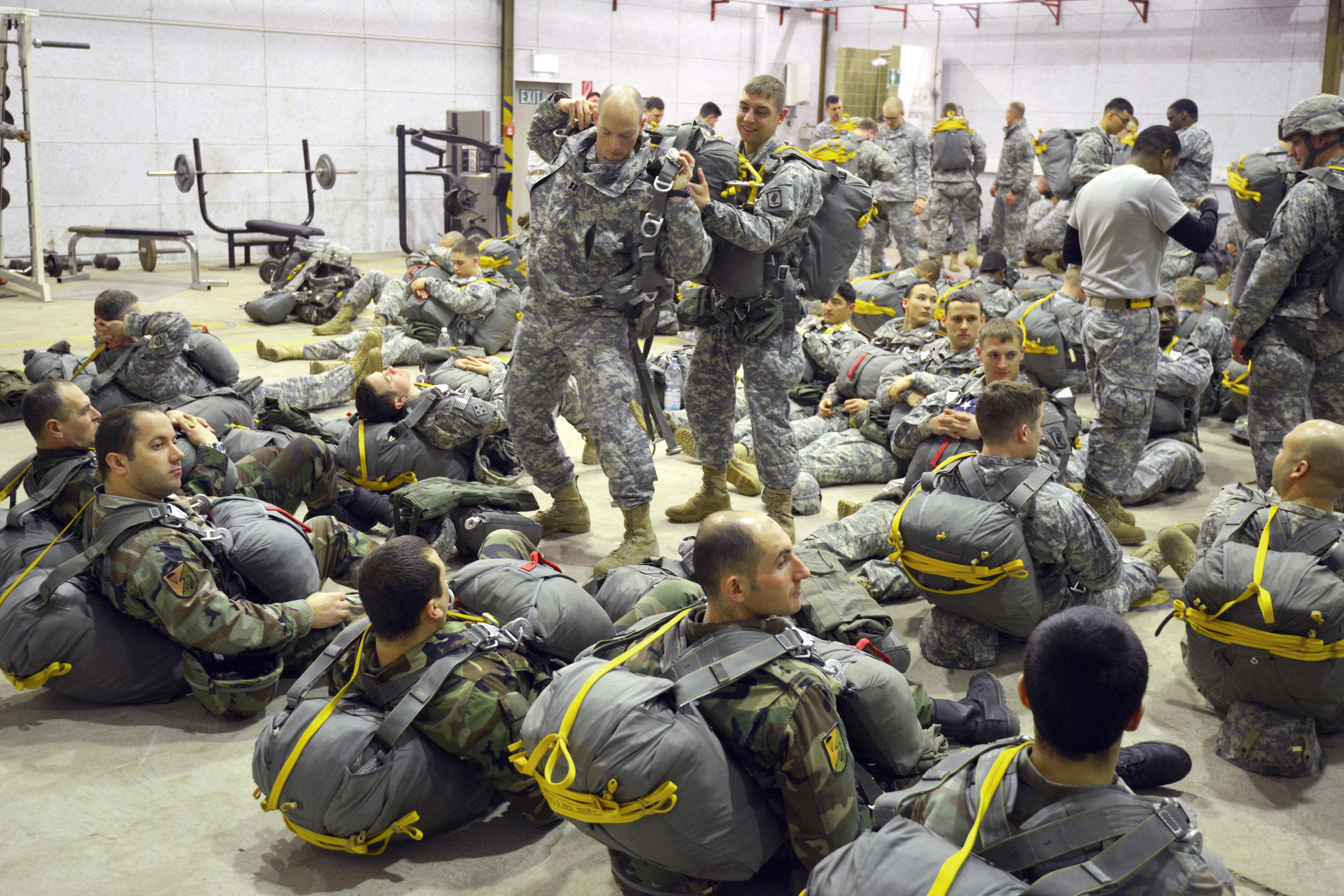 U.S. paratroopers conduct pre-jump inspections before an airborne ...