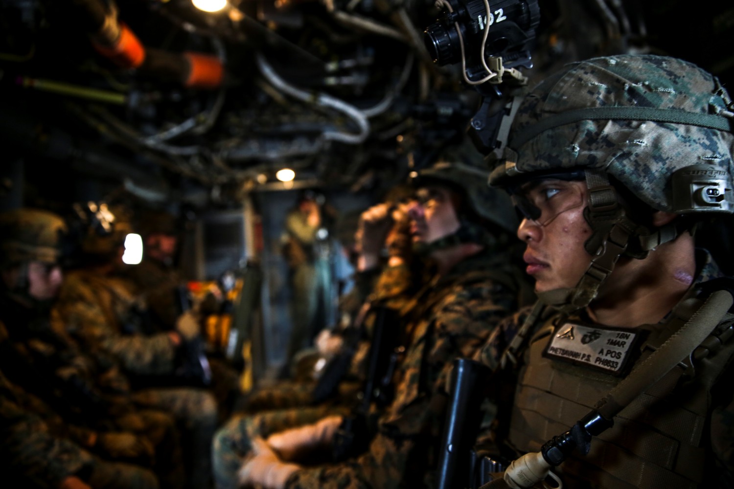 Marines conducting helo insertion to a nighttime urban terrain raid ...