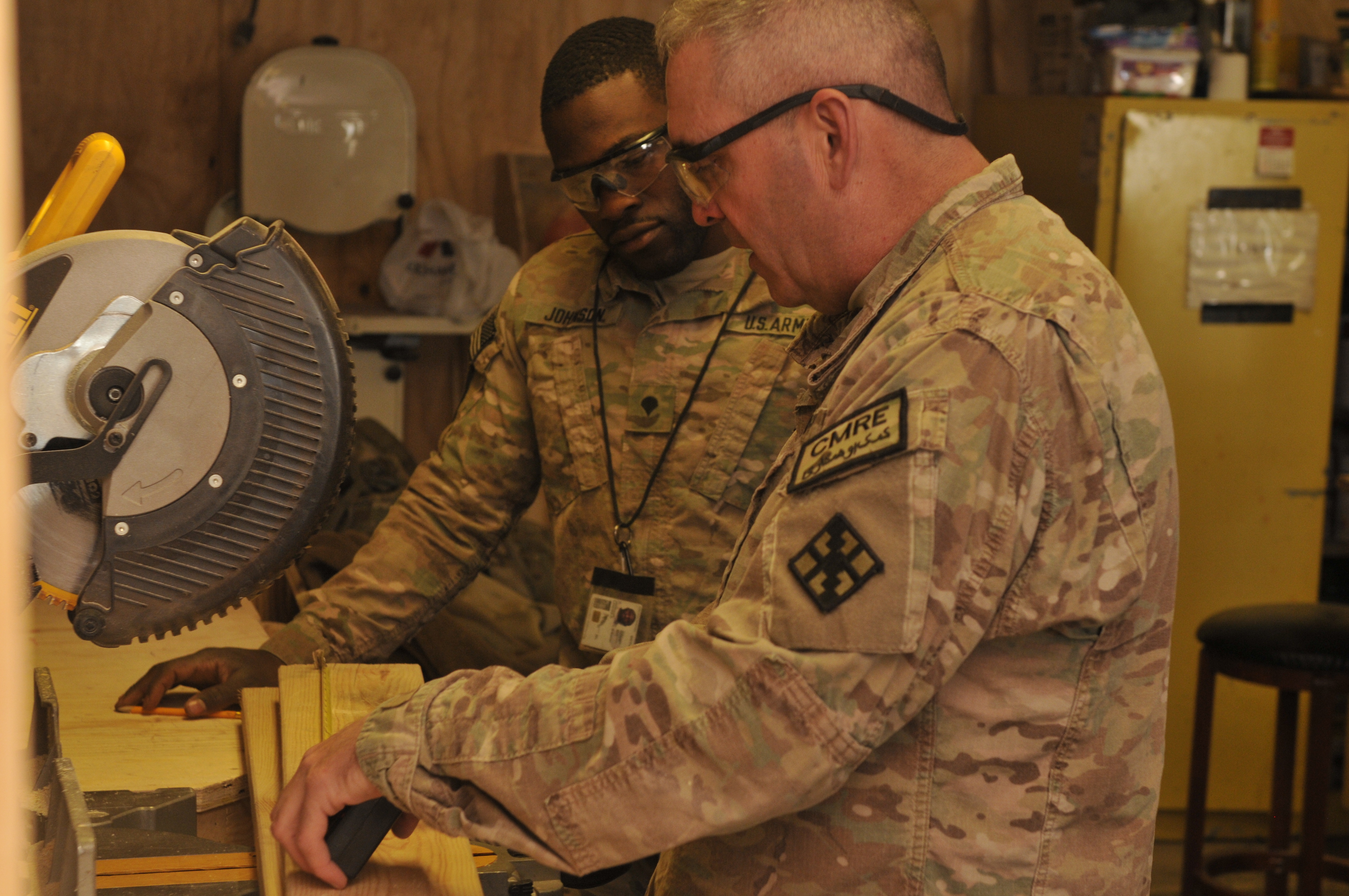 Army Warrant Officer Randy Jones teaches efficient and safe woodworking techniques in the 489th ...