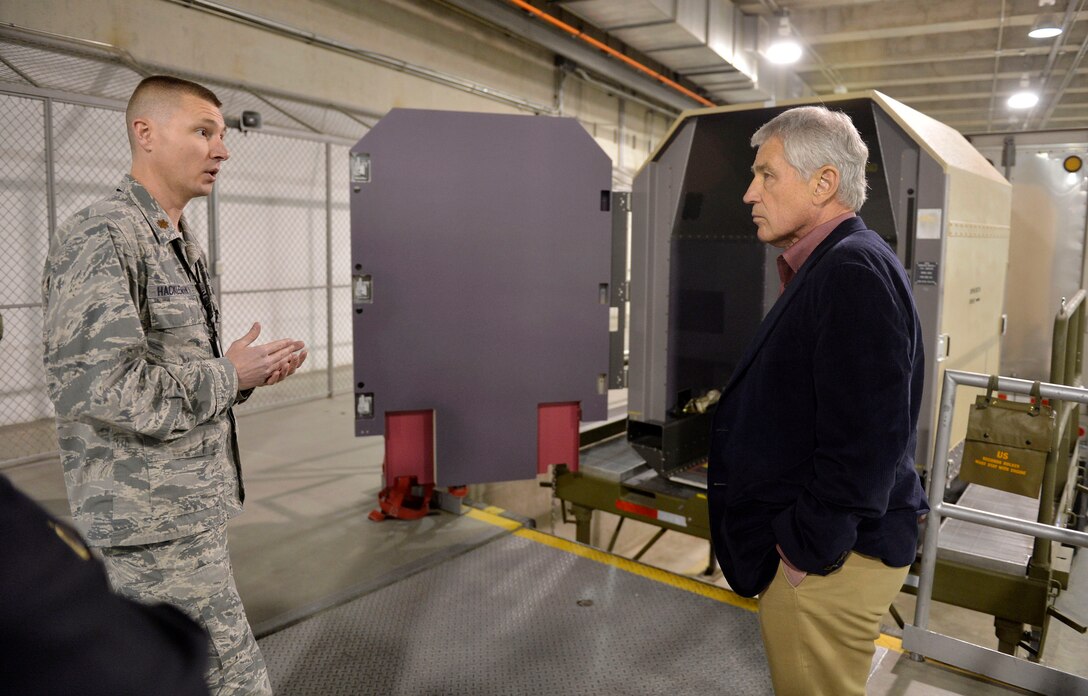Defense Secretary Chuck Hagel receives a brief from Air Force Maj ...