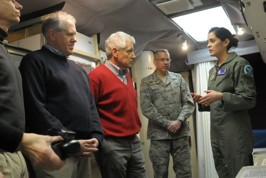 Defense Secretary Chuck Hagel, center, listens as Air Force Capt. Erin ...