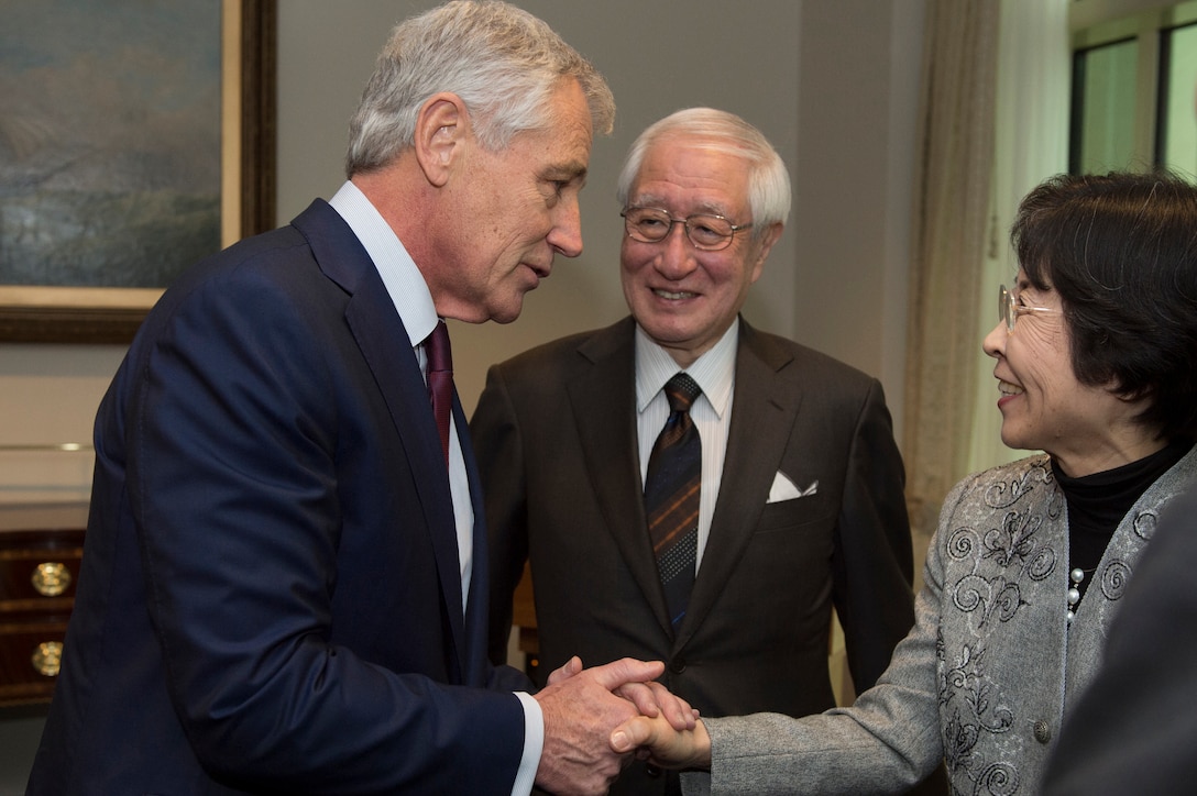 U.S. Defense Secretary Chuck Hagel, left, greets Ryozo Kato, the former ...