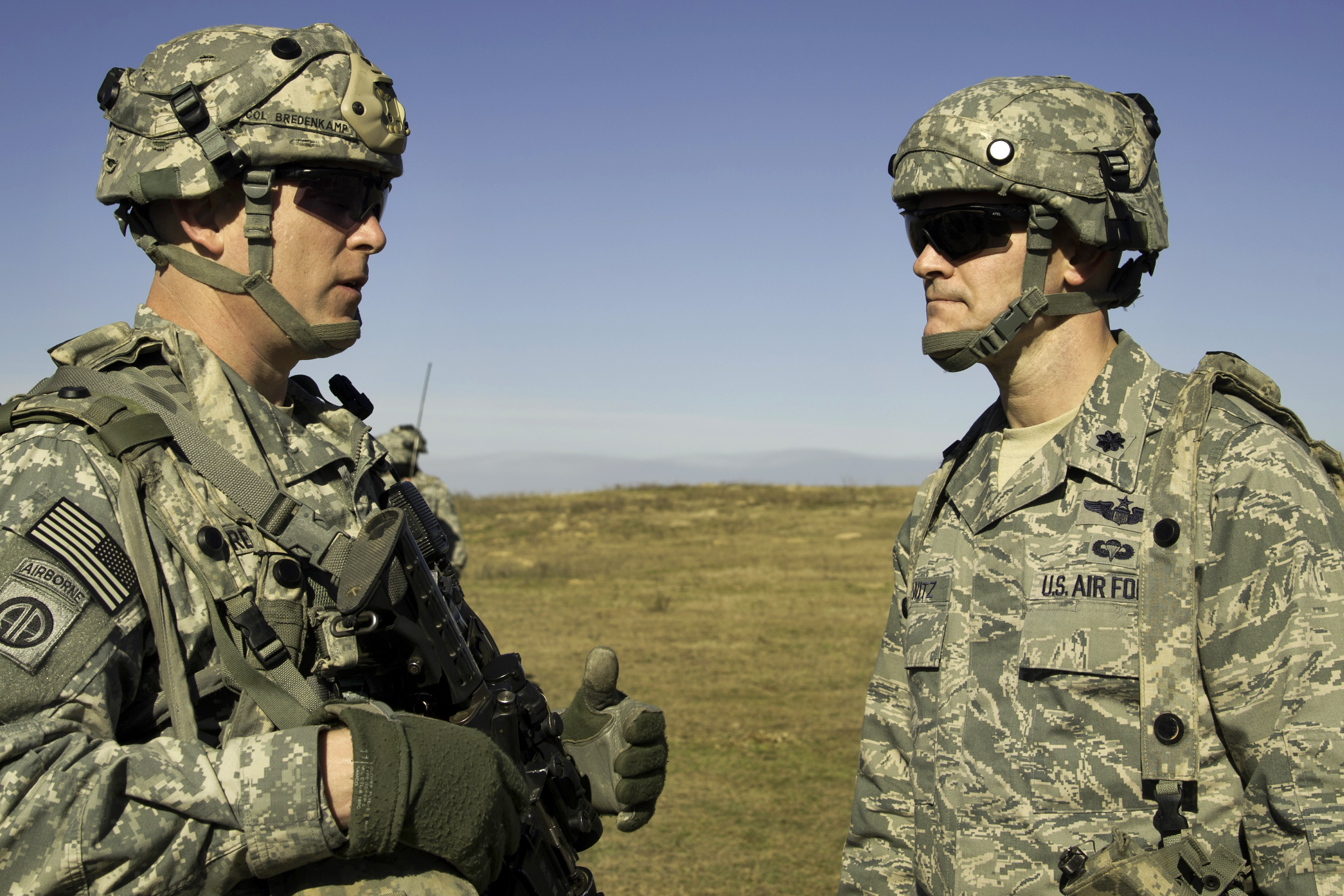 U.S. Army Col. Trevor Bredenkamp, left, speaks with Air Force Lt. Col ...