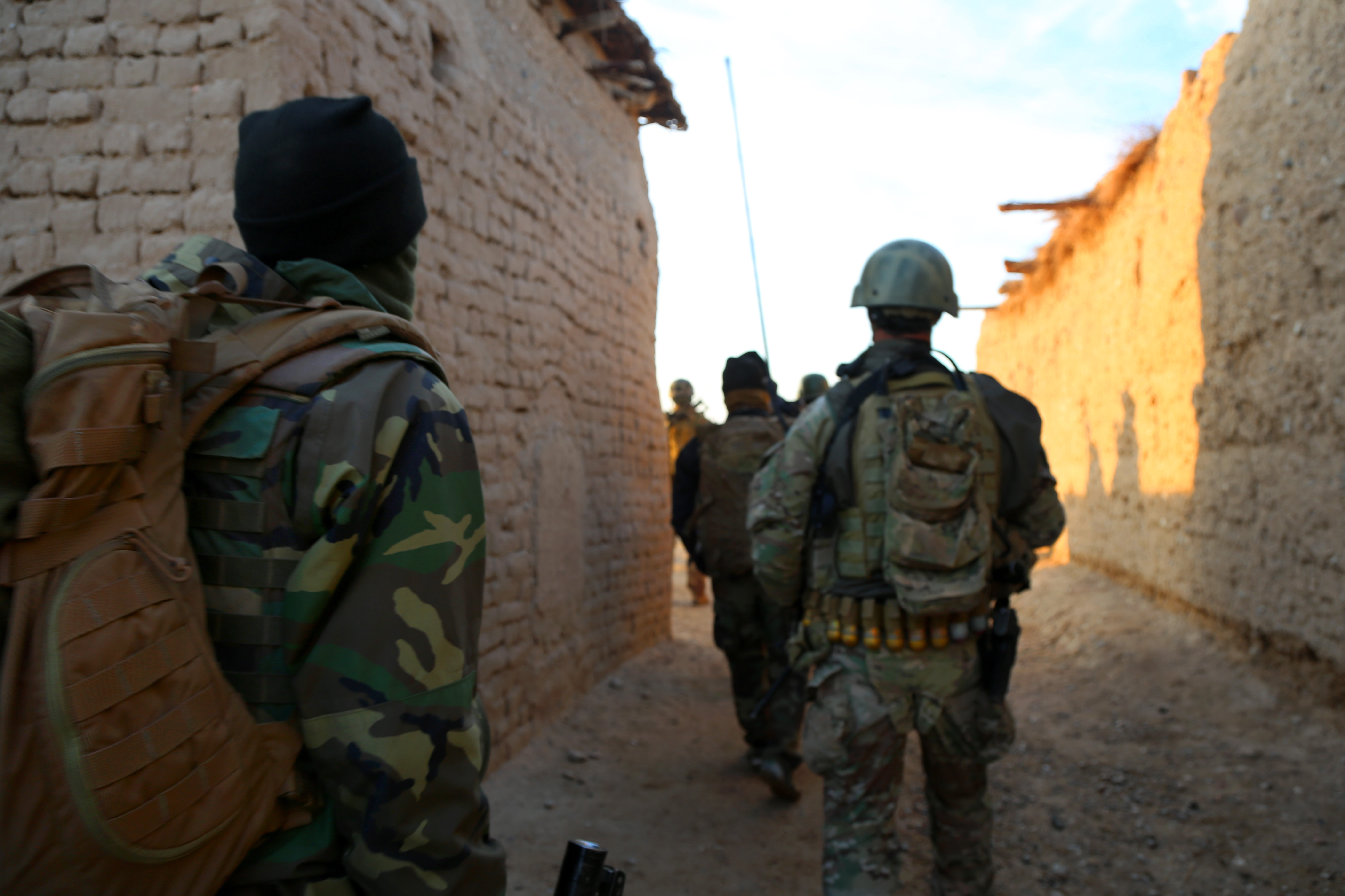 Afghan commandos and U.S. Army Special Forces soldiers patrol between ...