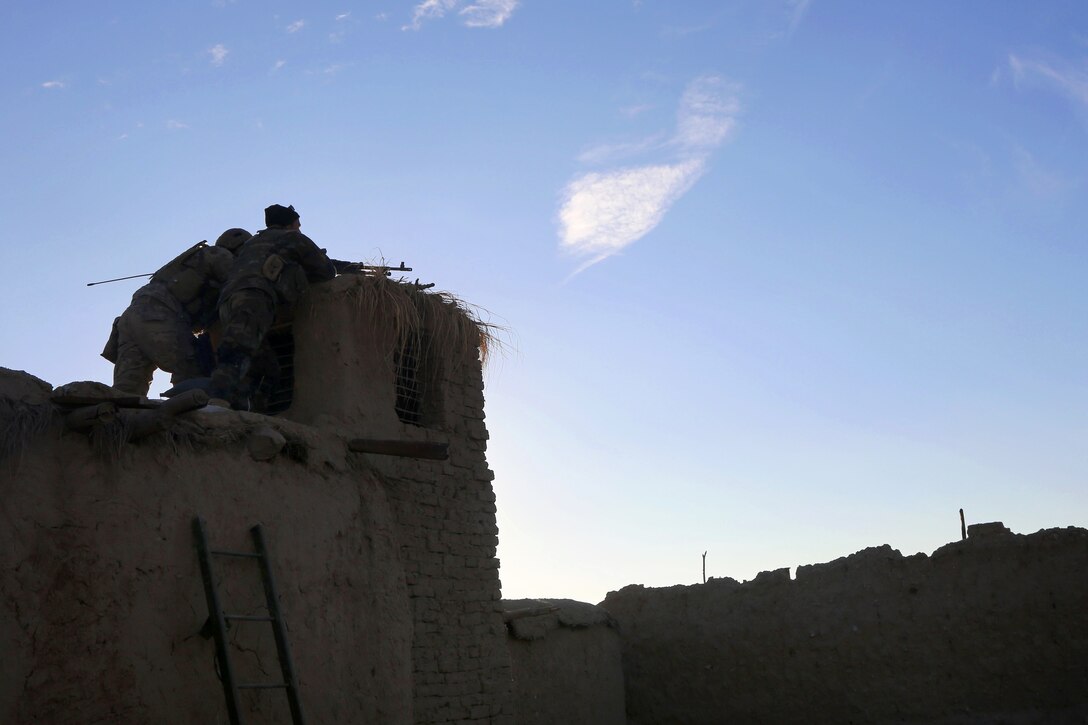 An Afghan commando, right, and U.S. Special Forces soldier watch for ...