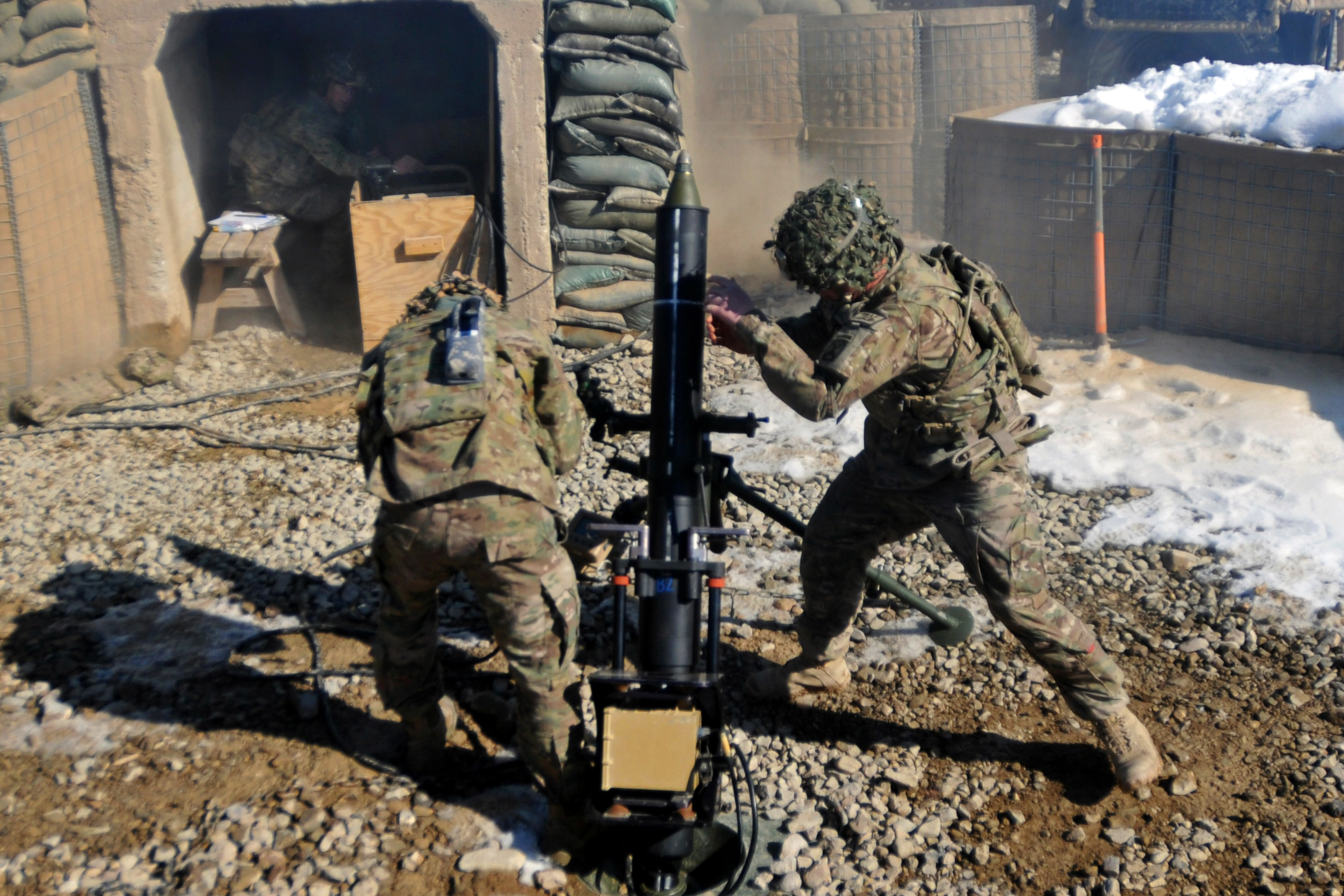 A U.S. soldier loads a round before firing their 120mm mortars during a ...