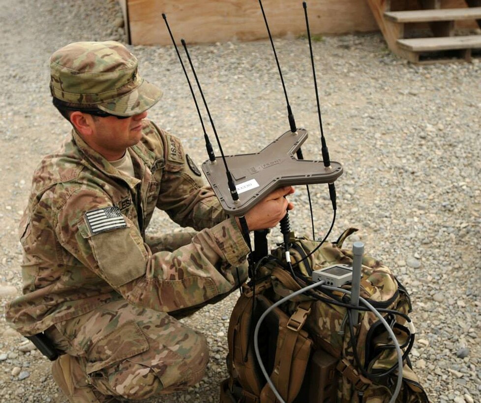 U.S. Army Sgt. John Leslie completes a system setup for a Wolfhound ...