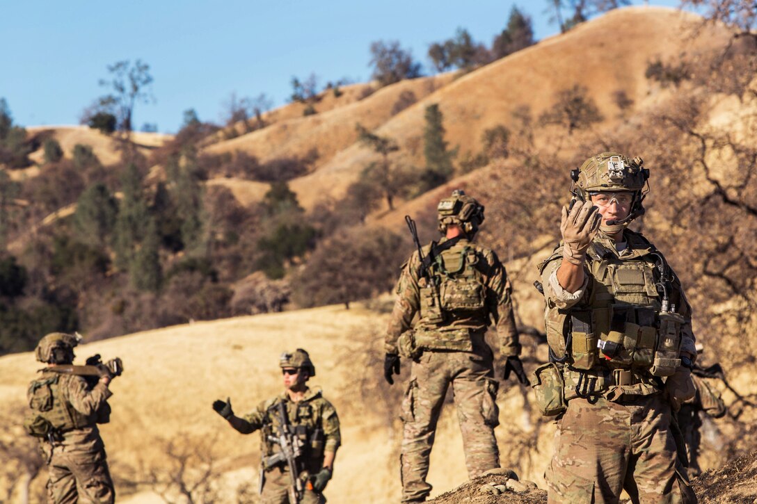 An Army Ranger directs movement during a Task Force training on Fort ...