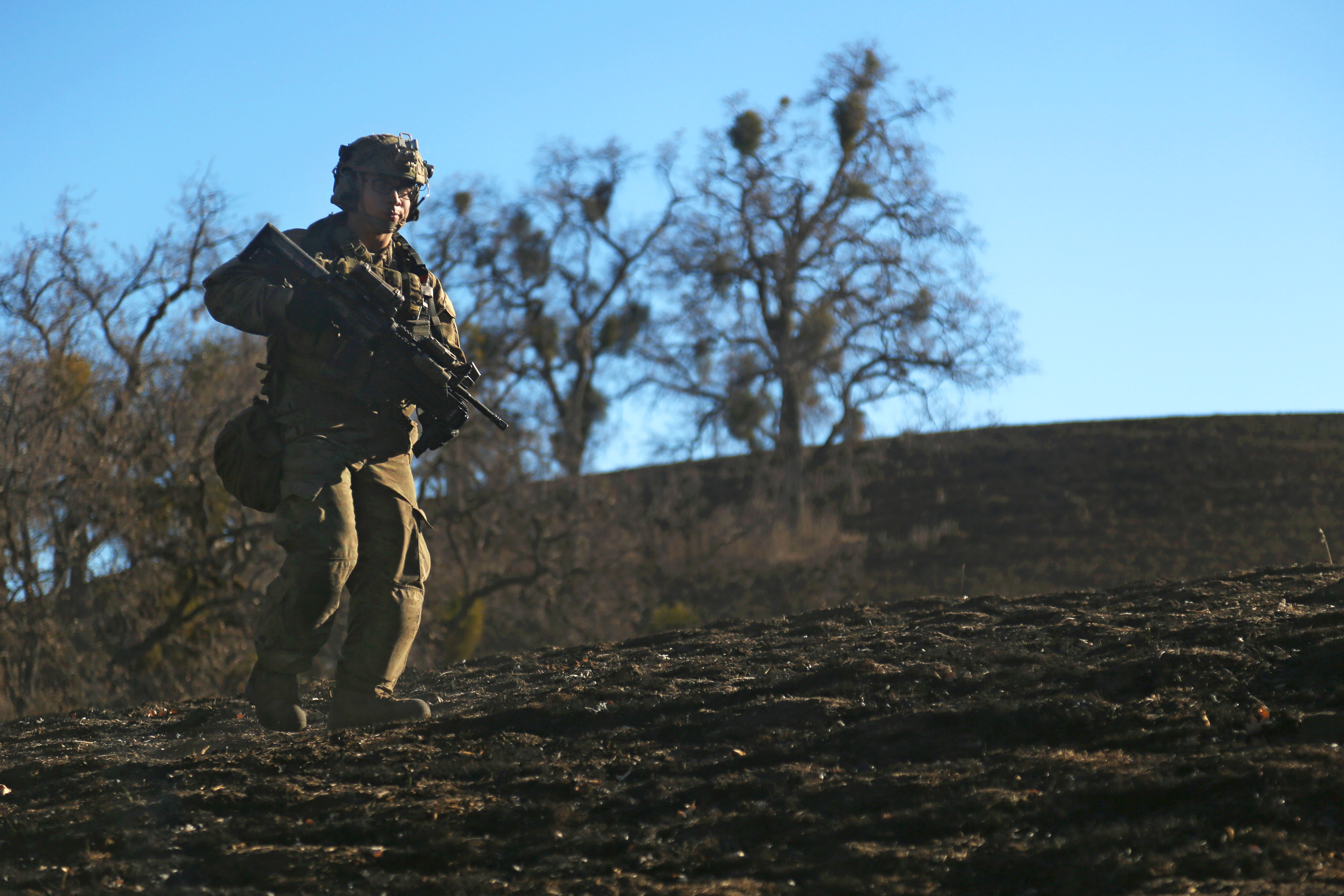 An Army Ranger moves to a fighting position during Task Force training ...