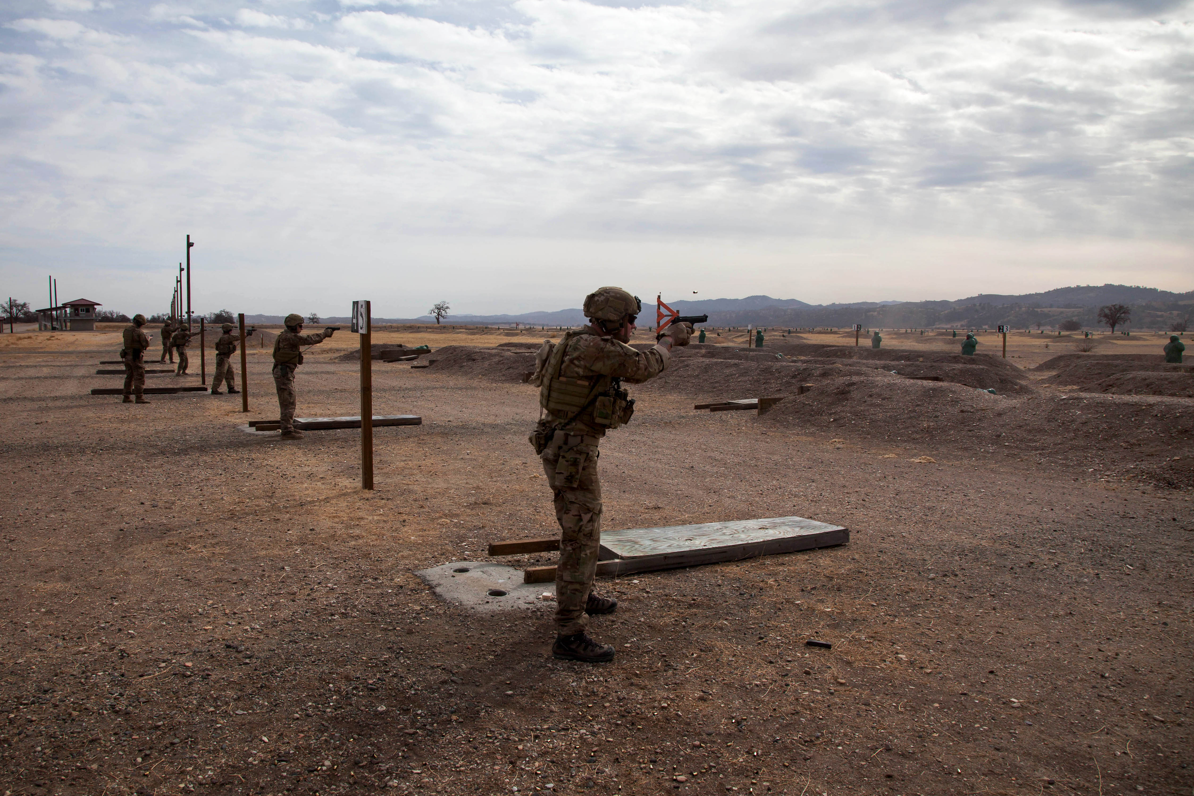 Army Rangers fire M9 9mm pistols at a range on Fort Hunter Liggett ...