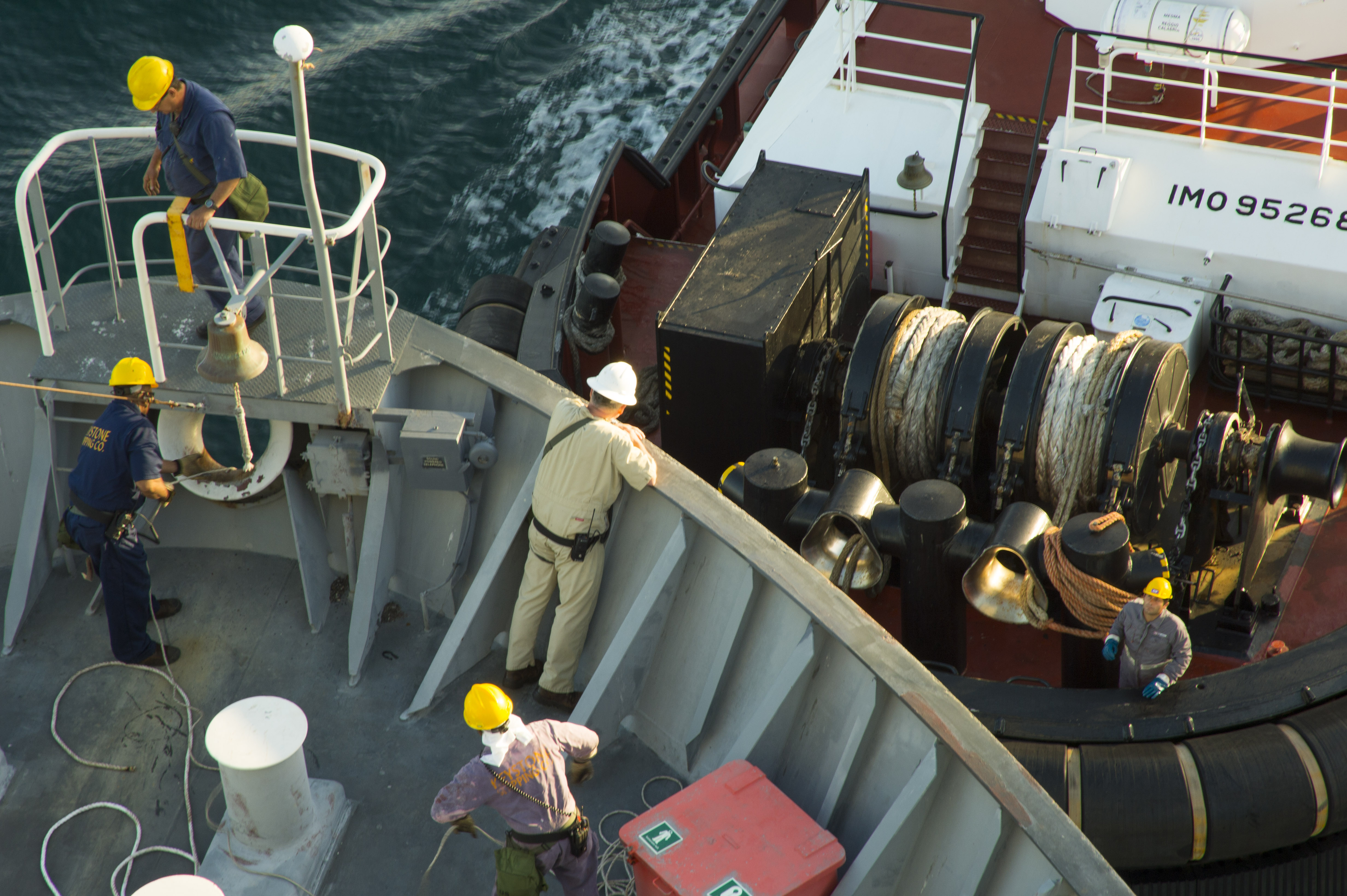 Line handlers aboard MV Cape Ray work with an Italian tugboat to moor ...