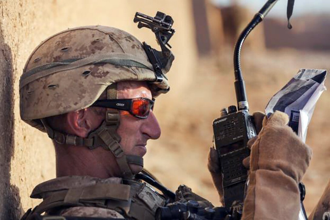 U.S. Marine Corps 1st Lt. Allen G. Frymire gives a position report over ...