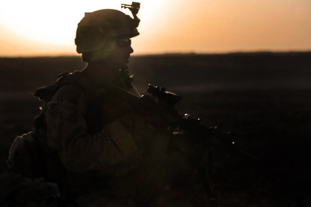 U.S. Marine Corps Cpl. Lucas A. Bankson observes his surroundings ...