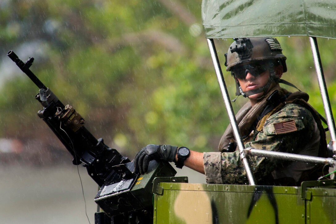 U.S. Navy Petty Officer 3rd Class Robert Robles mans his post during ...