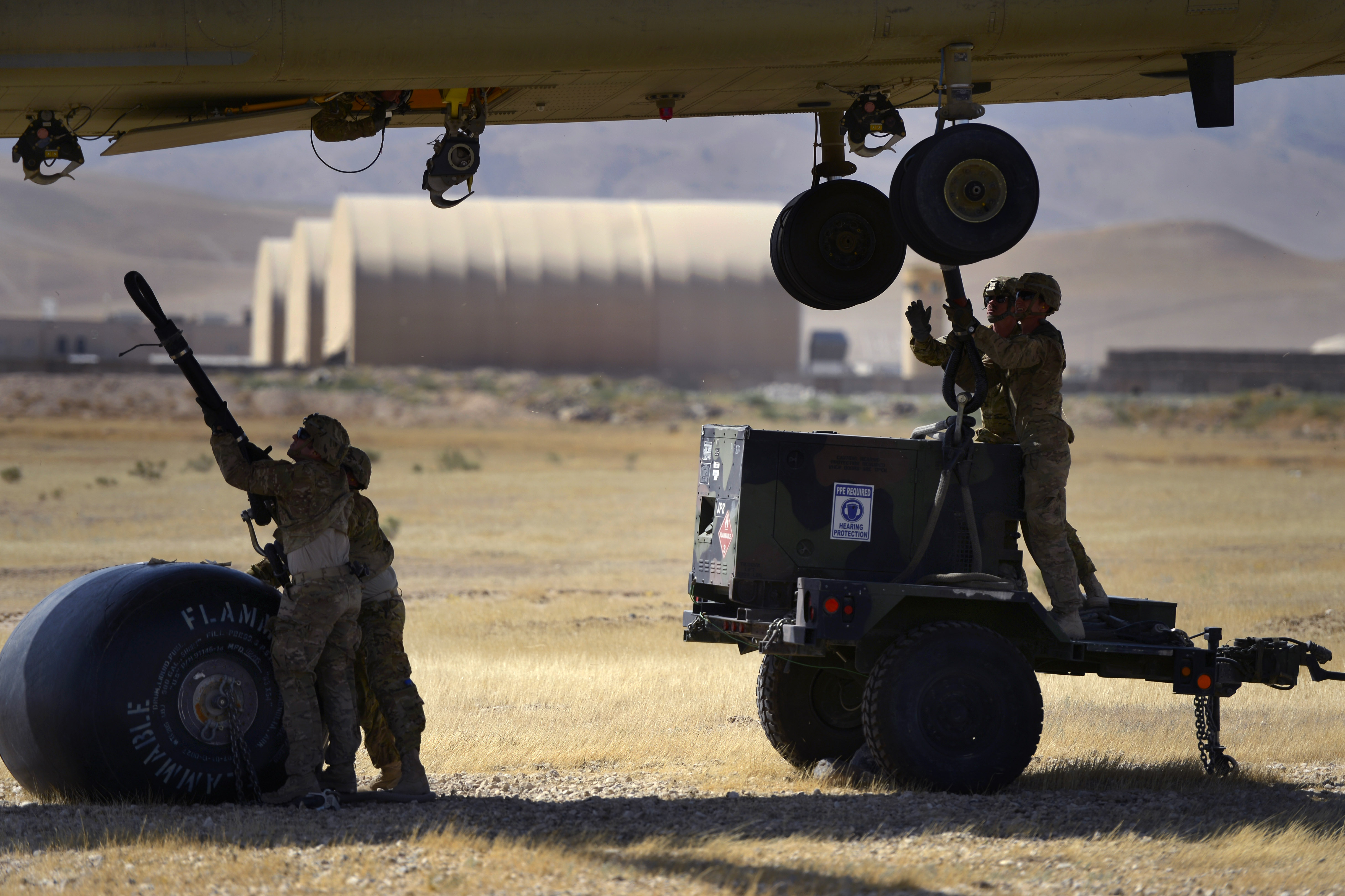 U.S. soldiers hook up a slingload to a CH-47 Chinook helicopter on Camp ...