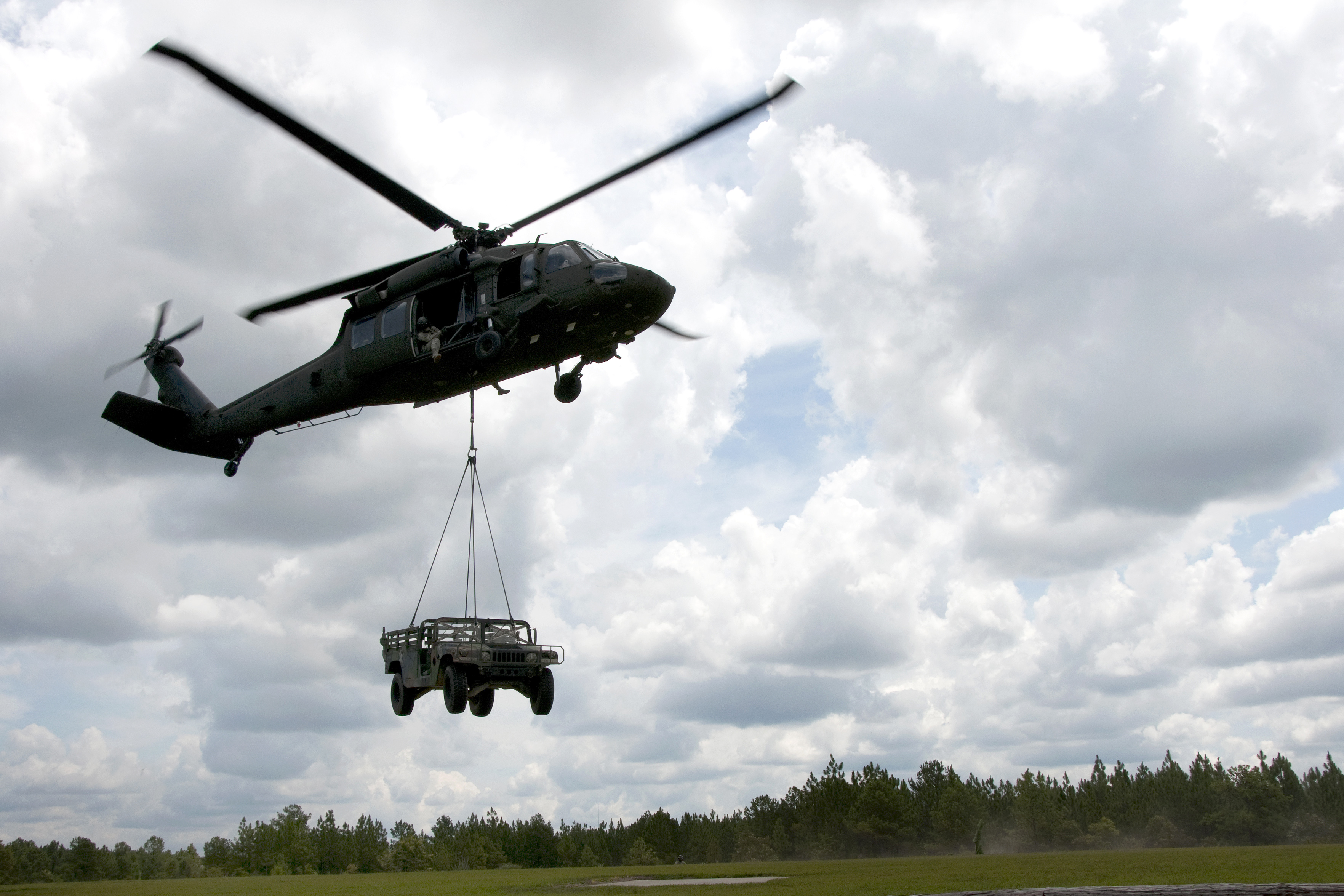 A UH-60 Black Hawk helicopter lifts off to practice slingload ...