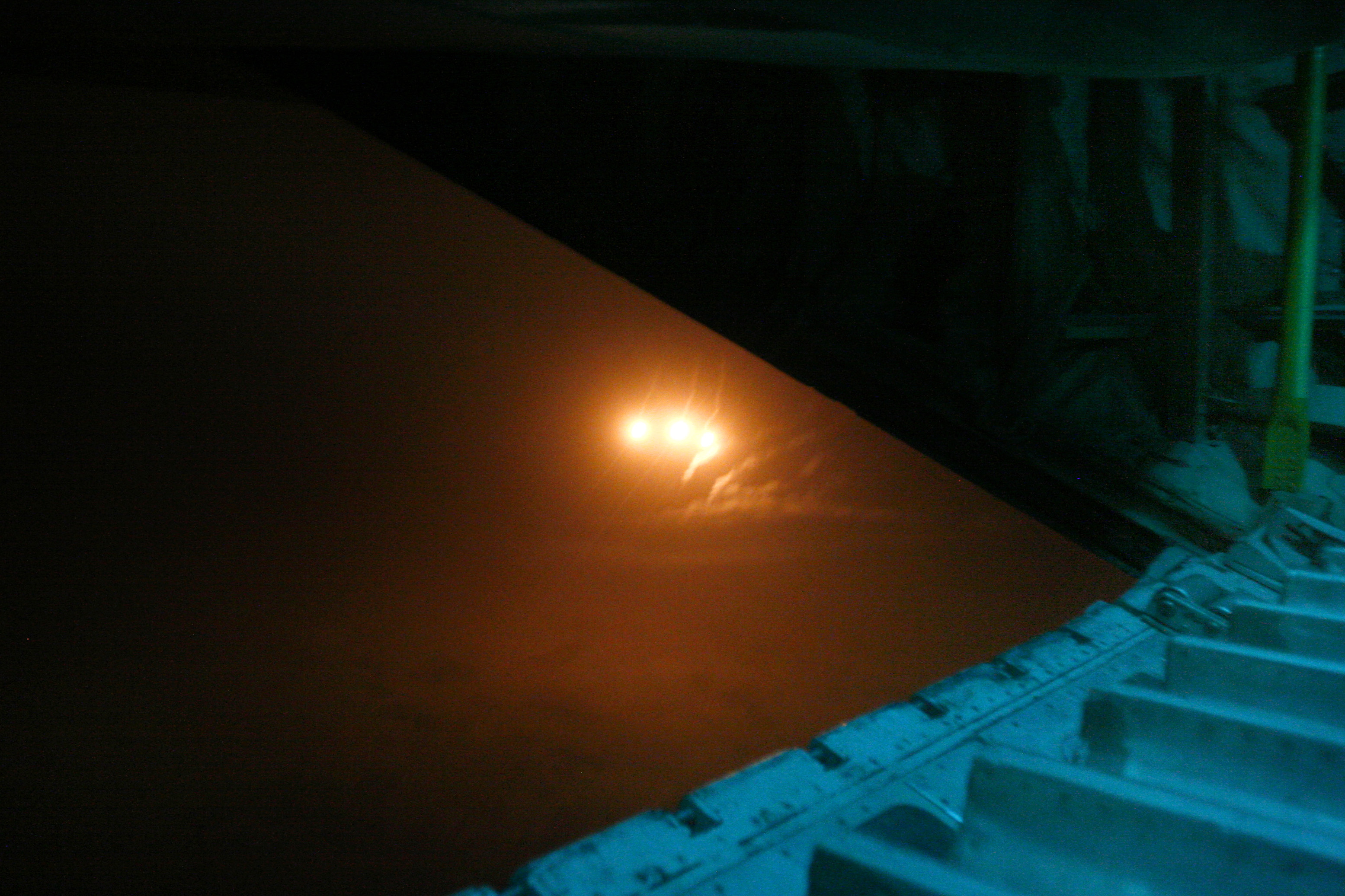 Flares dropped out the back of a KC-130J aircraft by U.S. Marines light ...