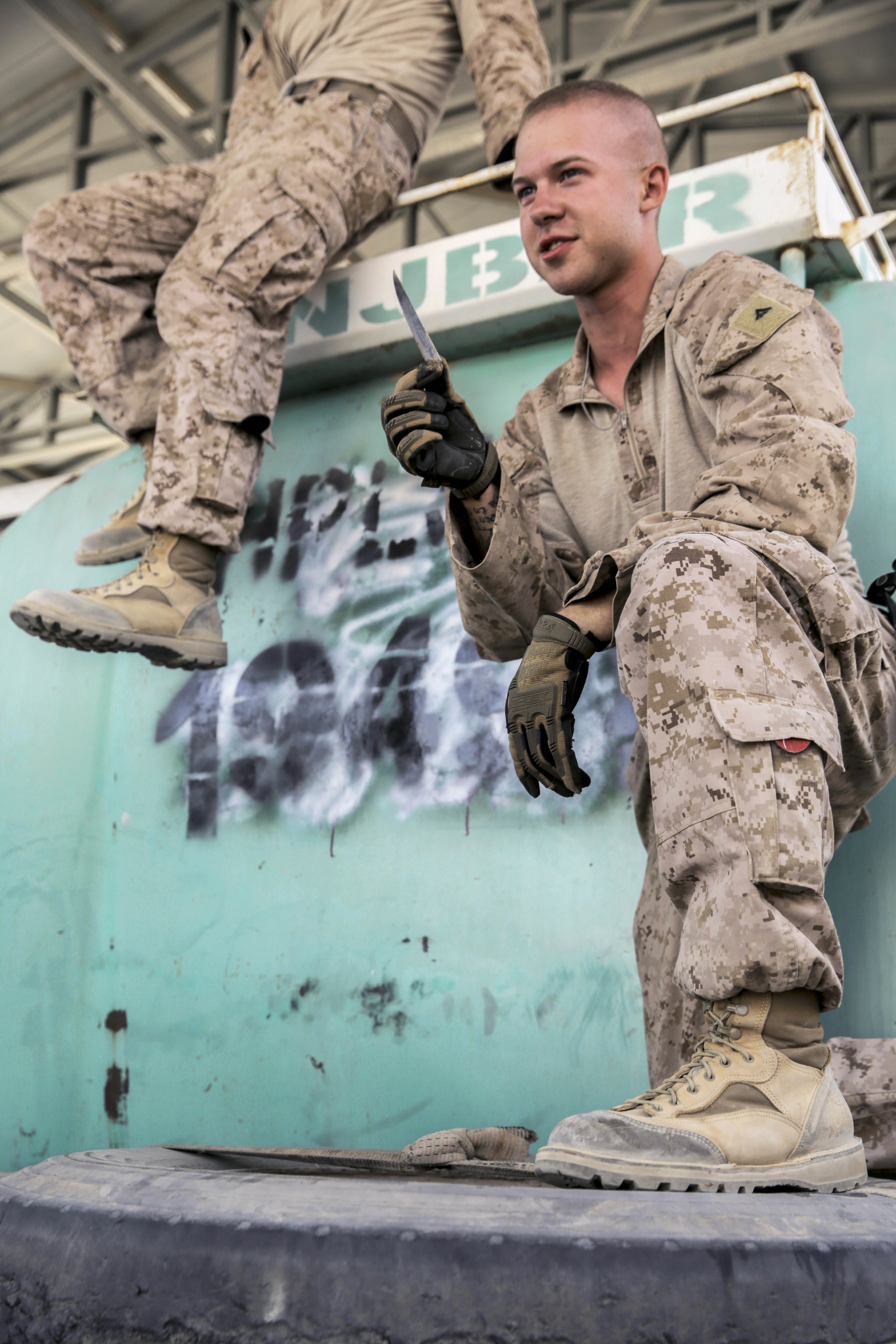 U.S. Marine Corps Lance Cpl. Sean Louis discovers a blade while ...