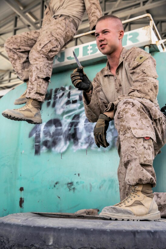 U.S. Marine Corps Lance Cpl. Sean Louis discovers a blade while ...