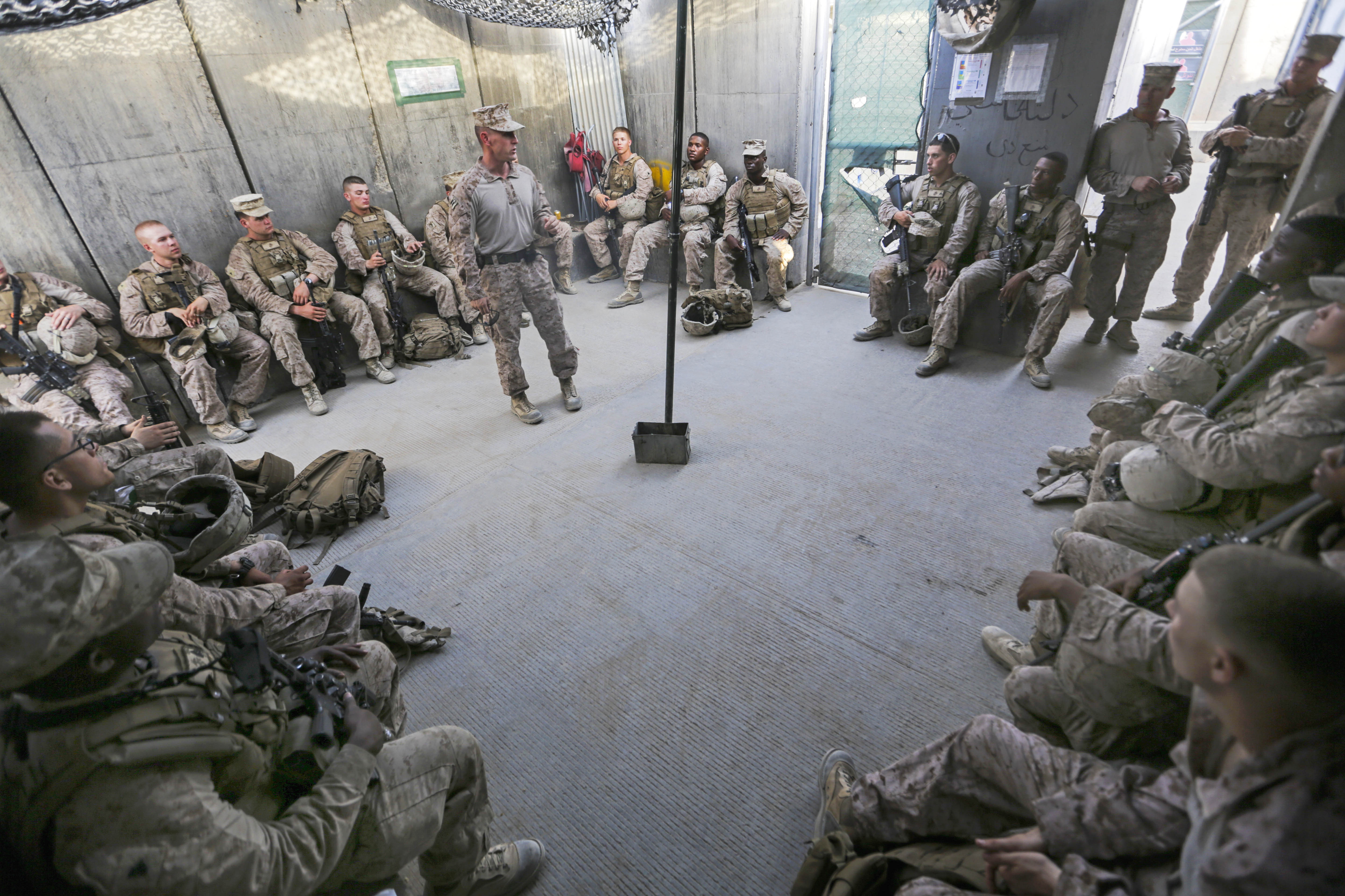 U.S. Marine Corps Captain James Geiger, center, explains his ...