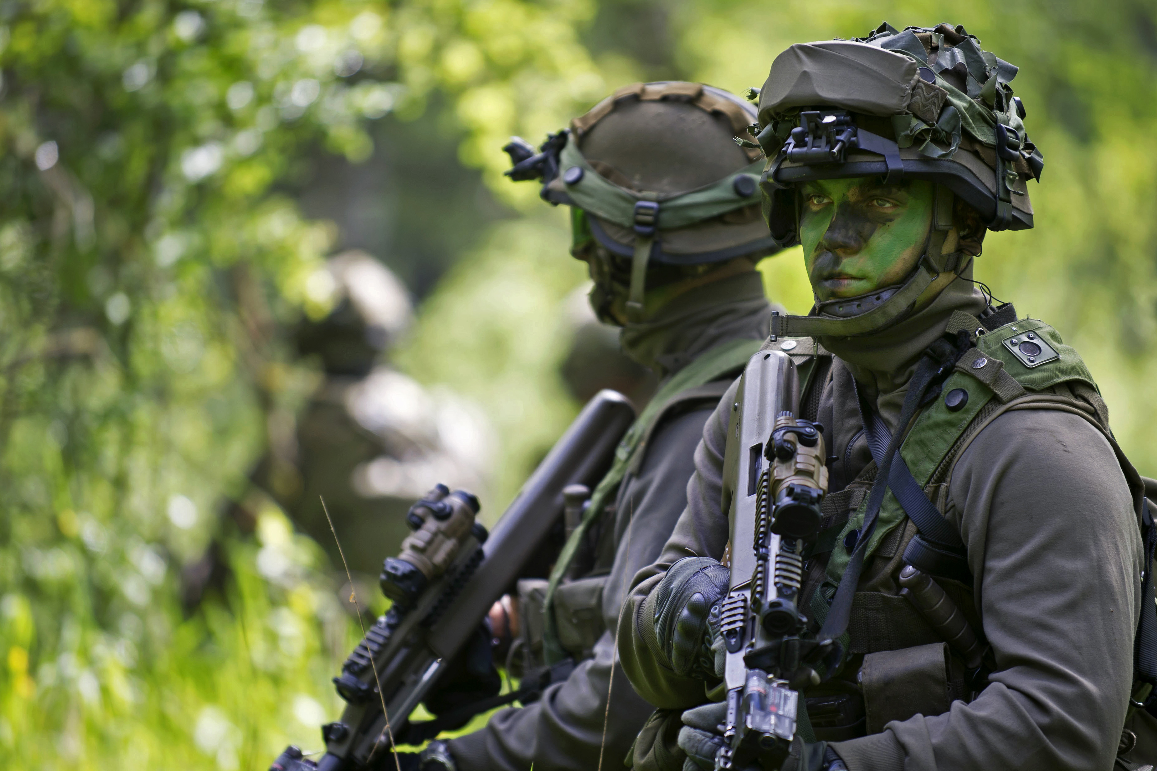 Austrian soldiers participate in a patrolling exercise while being ...