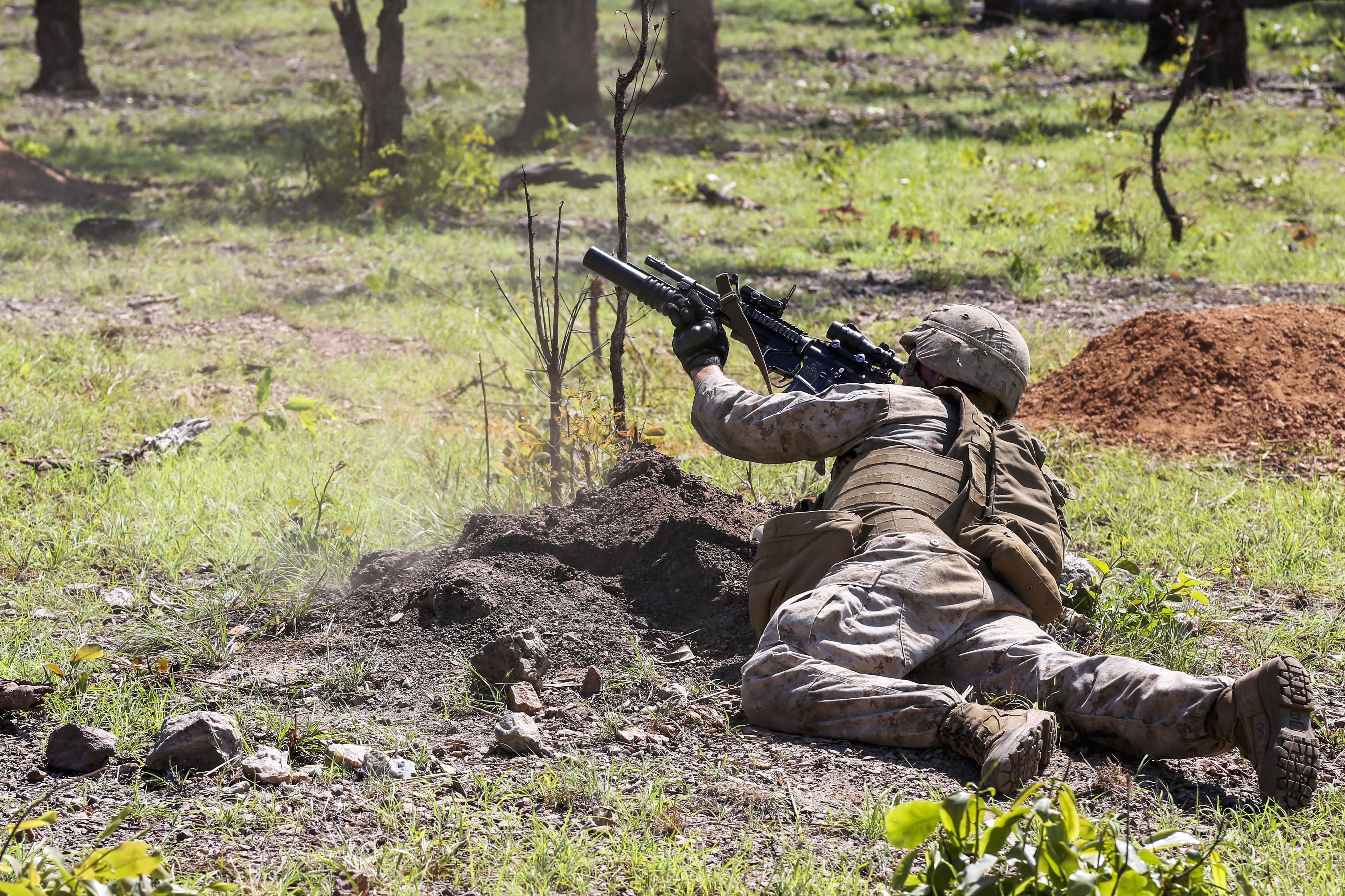 U.S. Marine Corps Lance Cpl. Joshua Williams loads a 40mm grenade ...