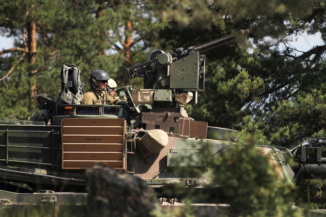 U.S. soldiers scan their sector from the gunners turret on a M1A1 ...