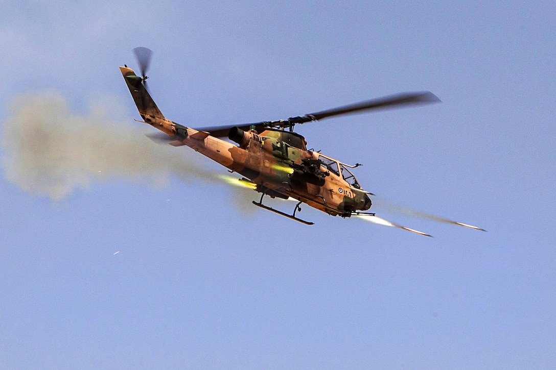 A Jordanian AH-1F Cobra helicopter attacks targets during combined arms ...