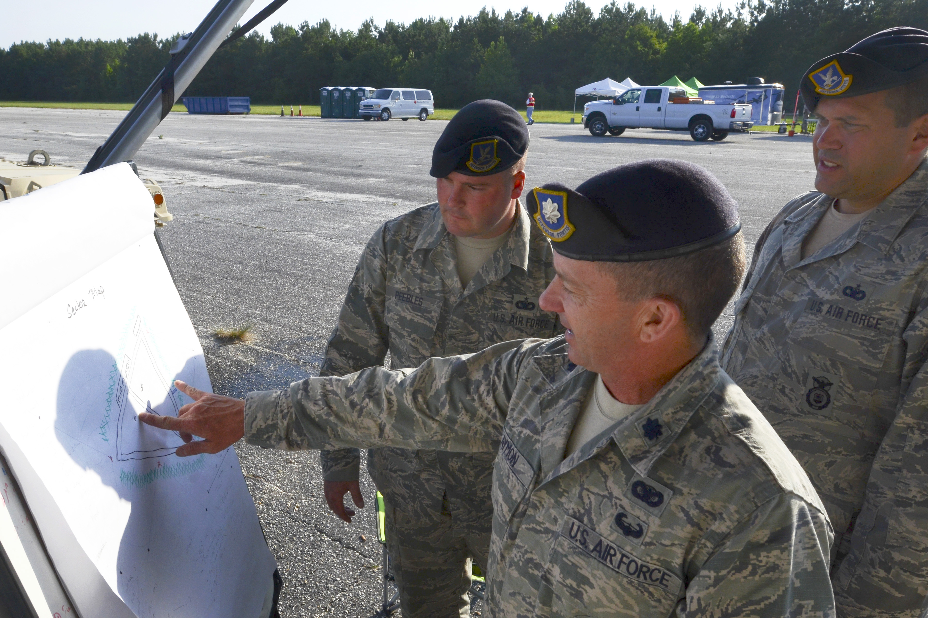 Air Force Lt. Col. Paul Laymon, center, explains to Air Force Staff Sgt ...