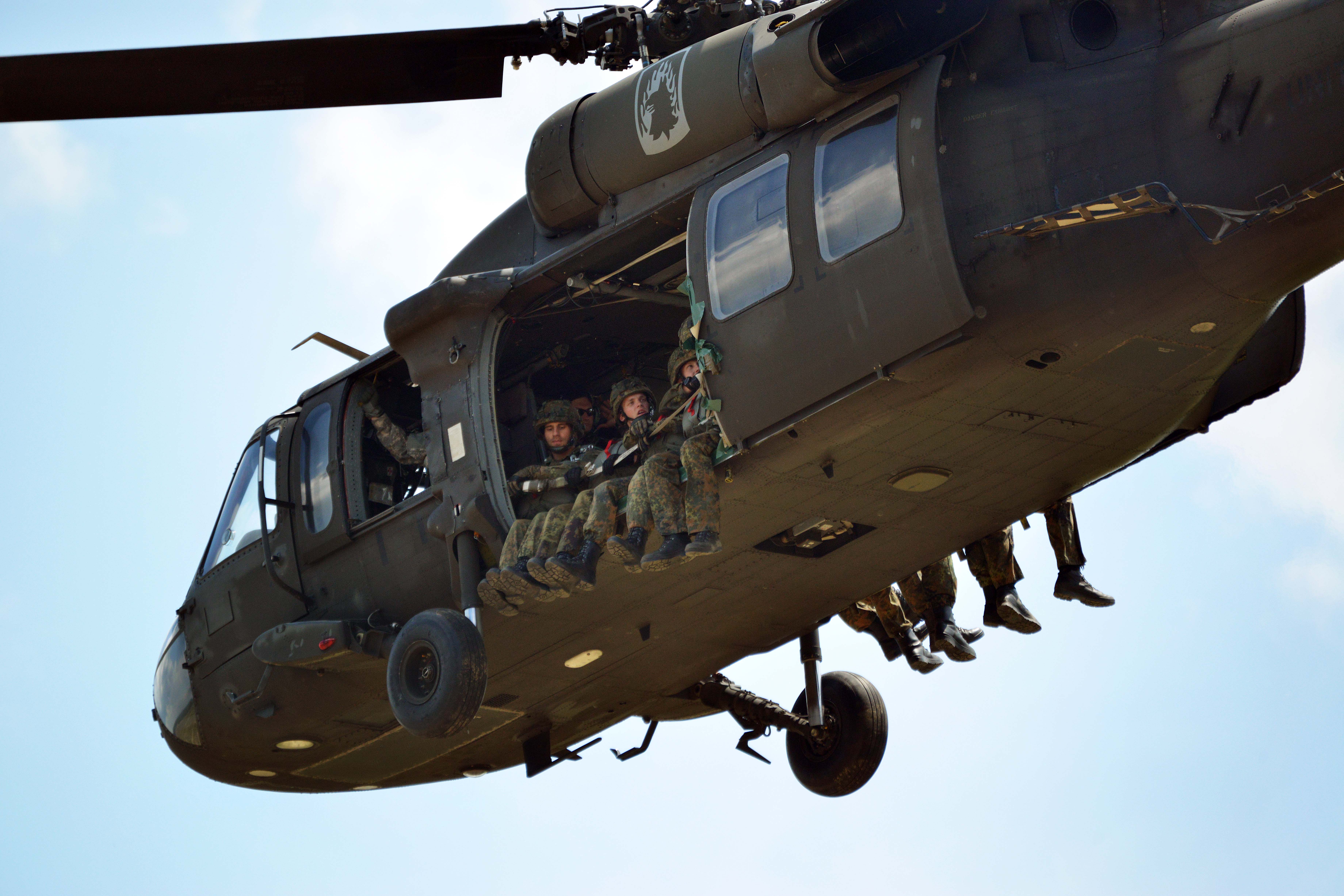 German paratroopers prepare to jump from a UH-60 Black Hawk helicopter ...