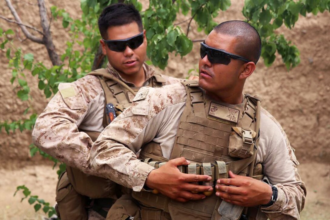 U.S. Marine Corps Lance Cpl. Jesse Gutierrez, foreground, secures 40mm ...
