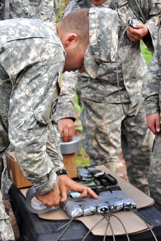 A soldier prepares linear charges, water impulse charges, and field ...