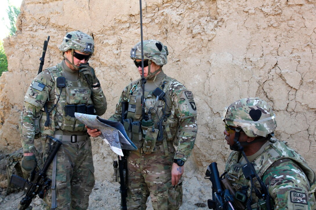 U.S. Army 1st Lts. Matthew White, left, and Kenneth Hurst, center, hold ...