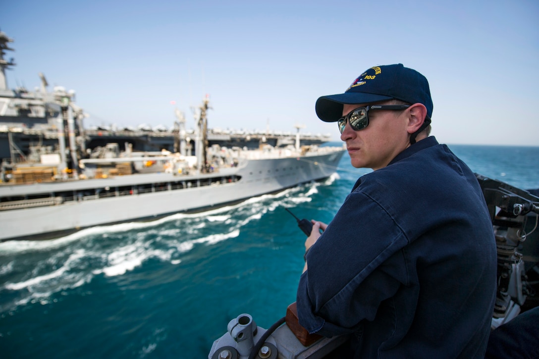 U.S. Navy Lt. Thomas Danner stands watch aboard the guided-missile ...